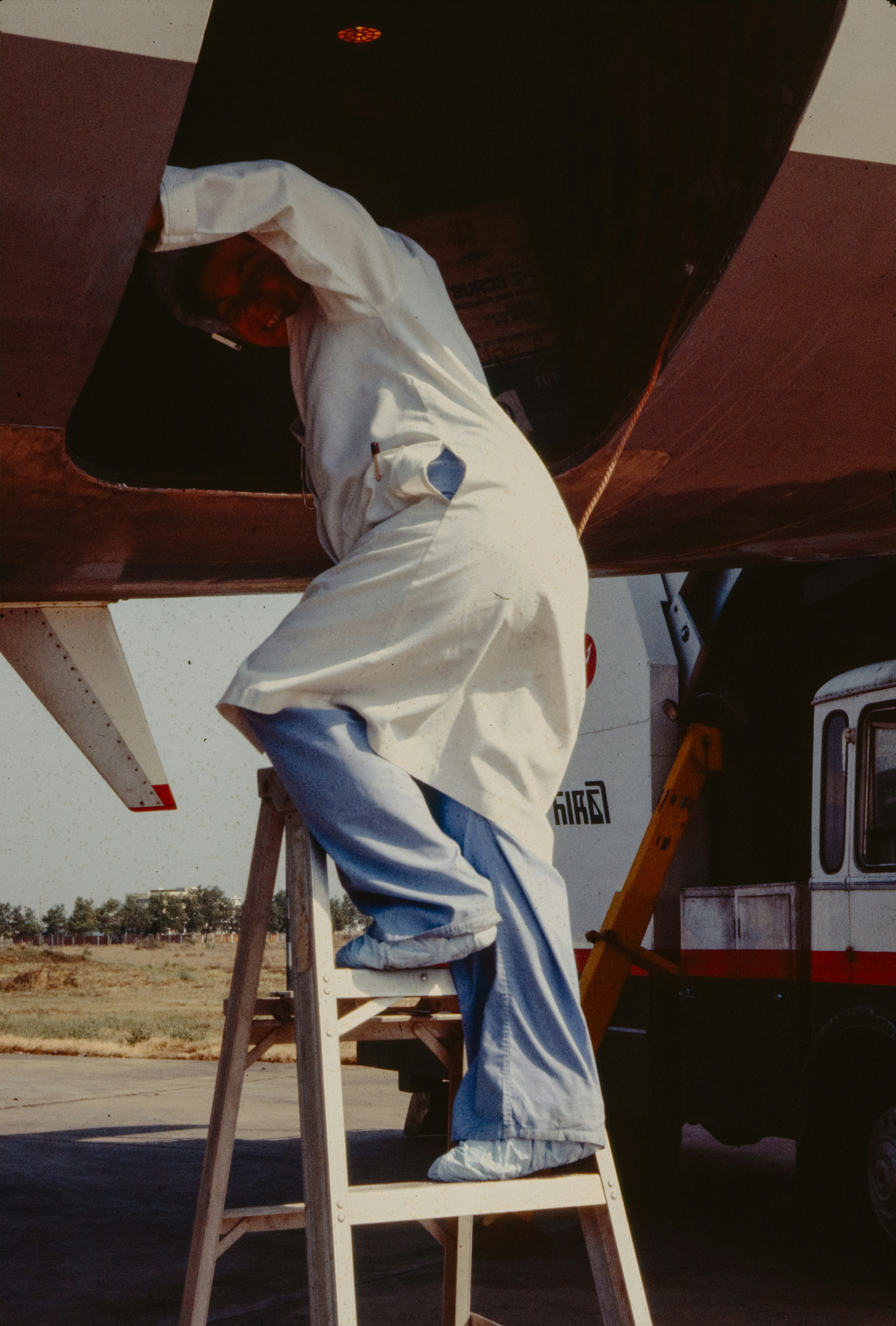 Climbing into the Dark: Technician Scrambles Underneath a Transformed Wing