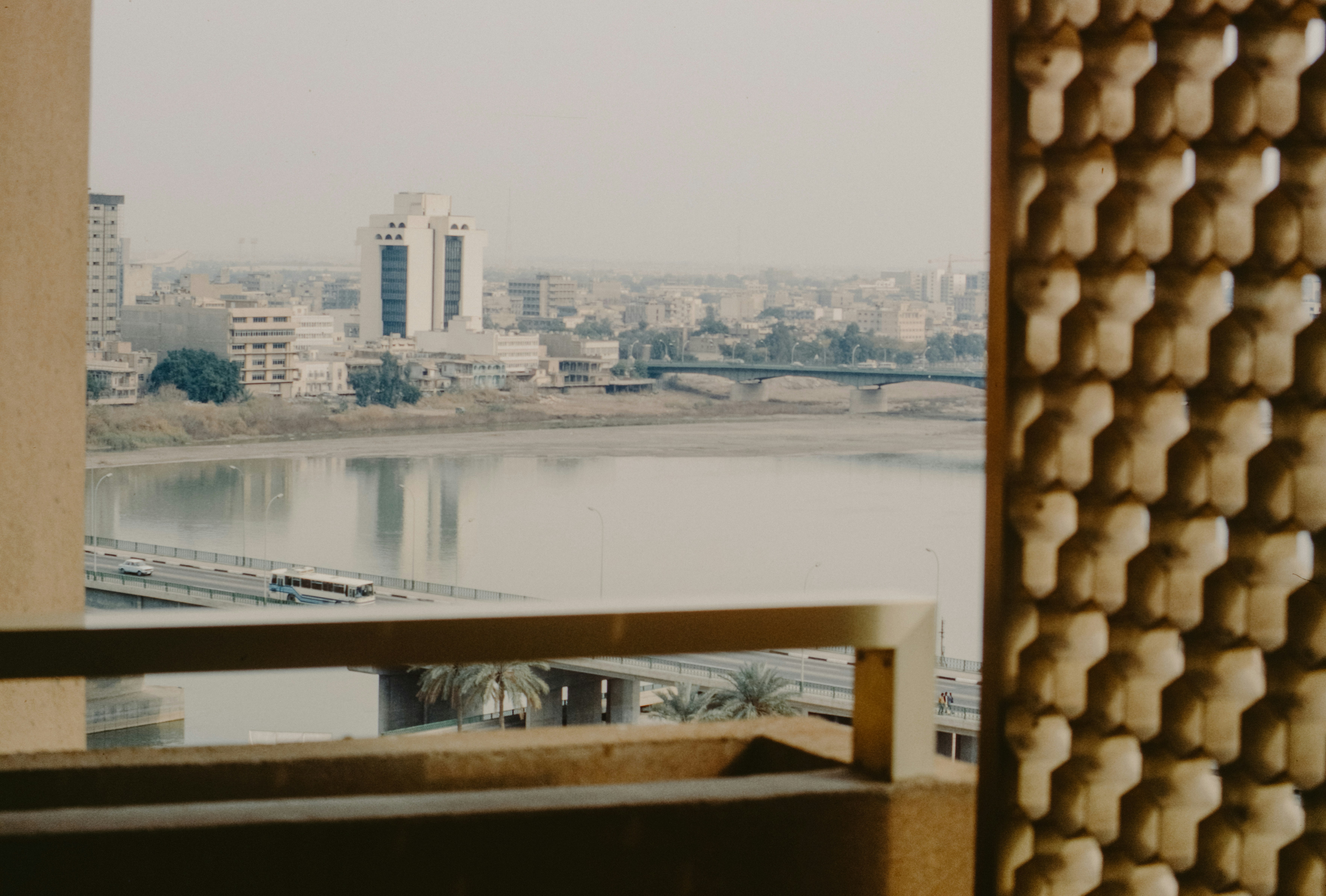 Cityscape with river and bridge seen through lattice