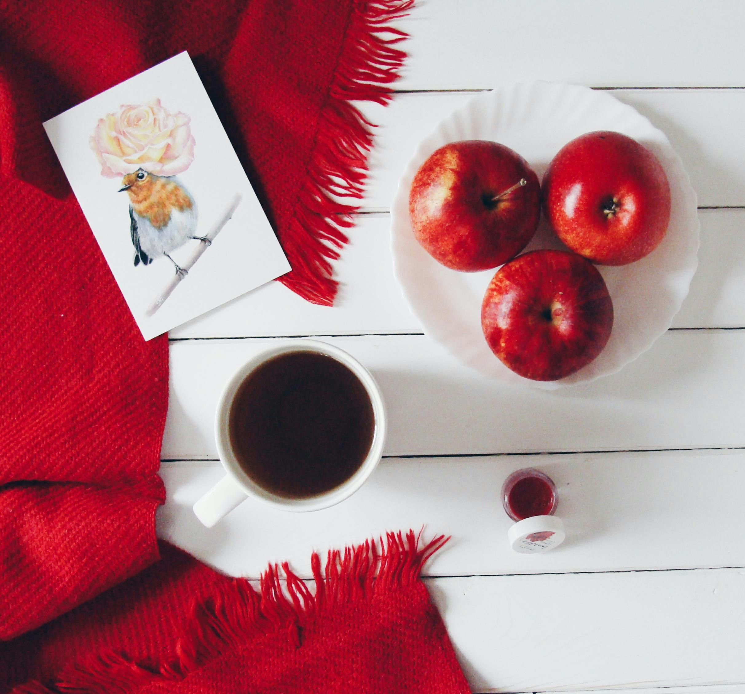 Red Morning Pause: A Cozy Scene of Apples, Card, and Coffee