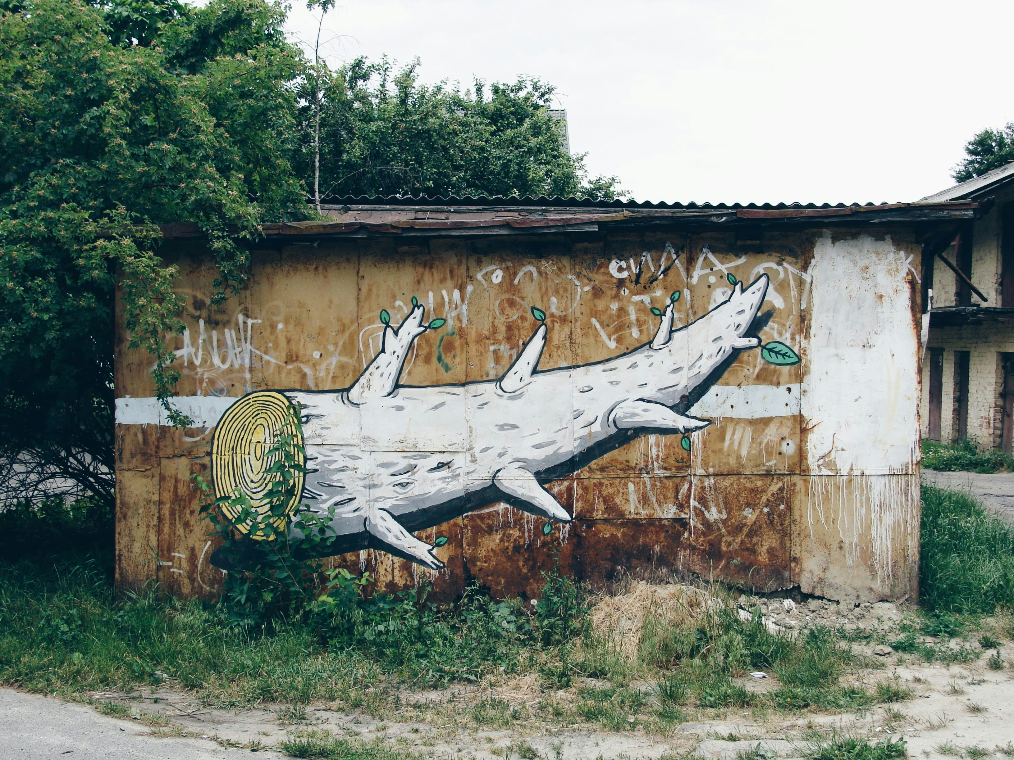 Graffiti Gulliver: A White Dragon-Limb mural sprawls across a rusted wall