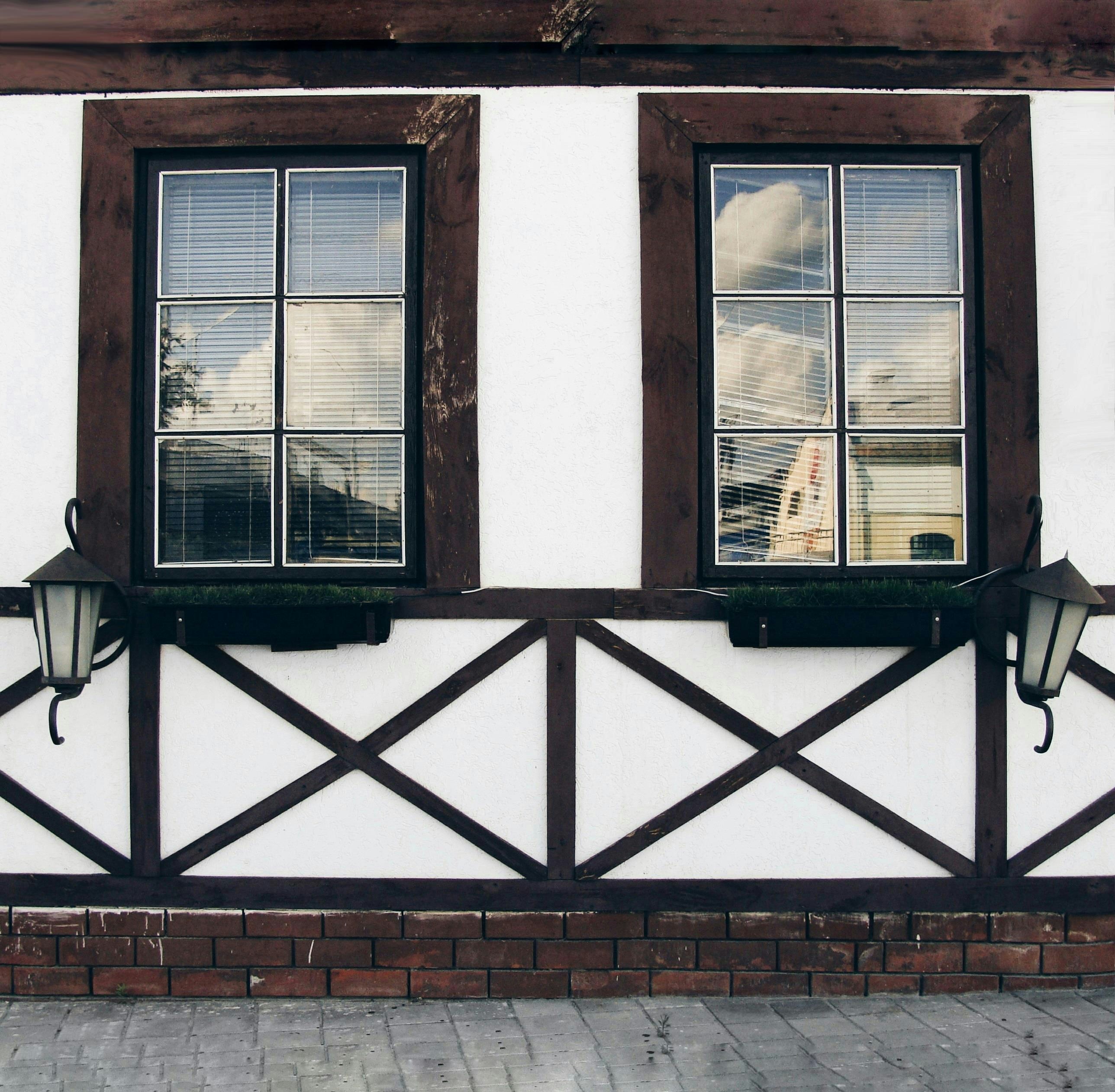 Tudor-Frame Facade: Symmetry Amidst Brickwork and Glass