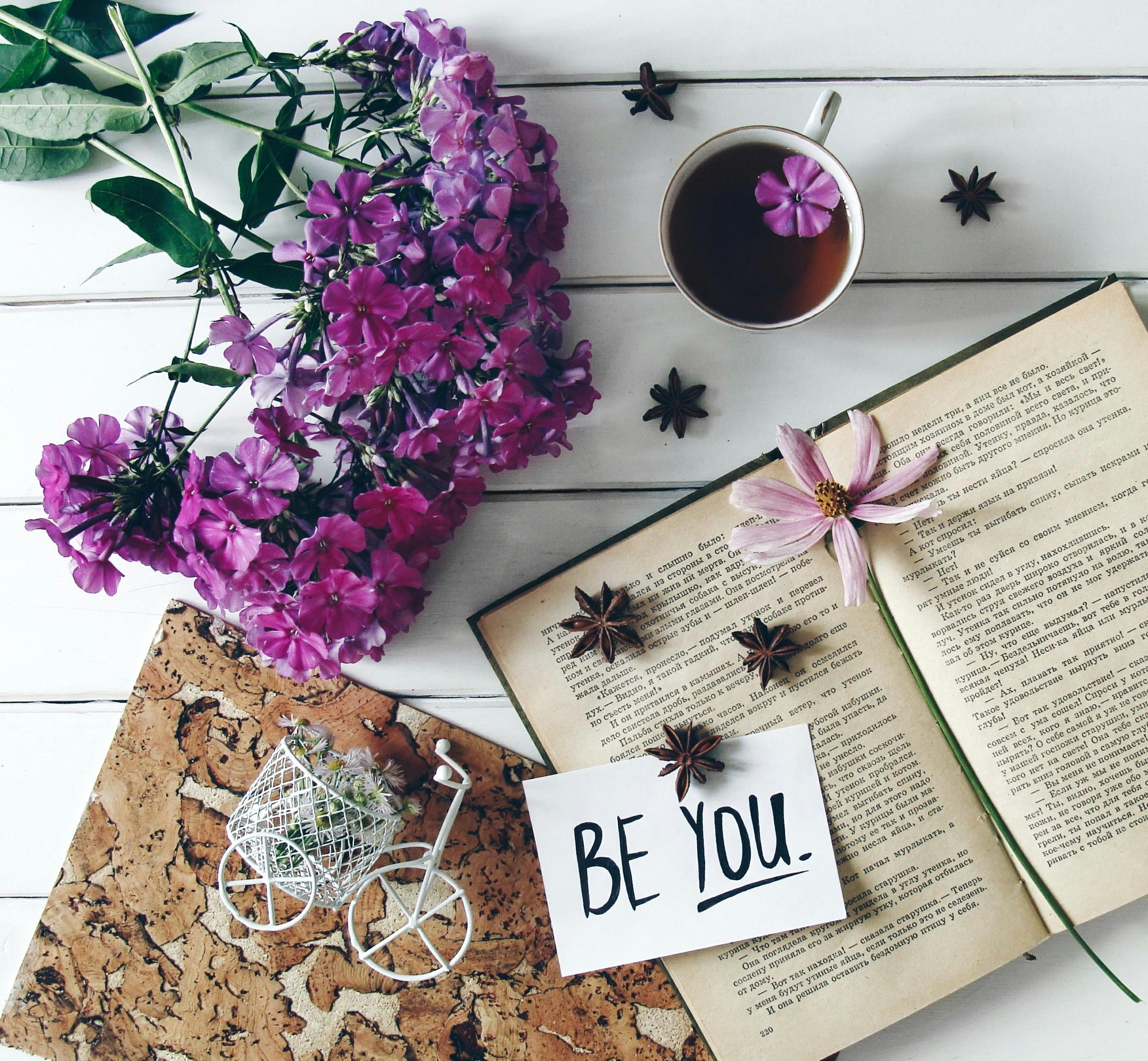 white flatlay book flowers tea
