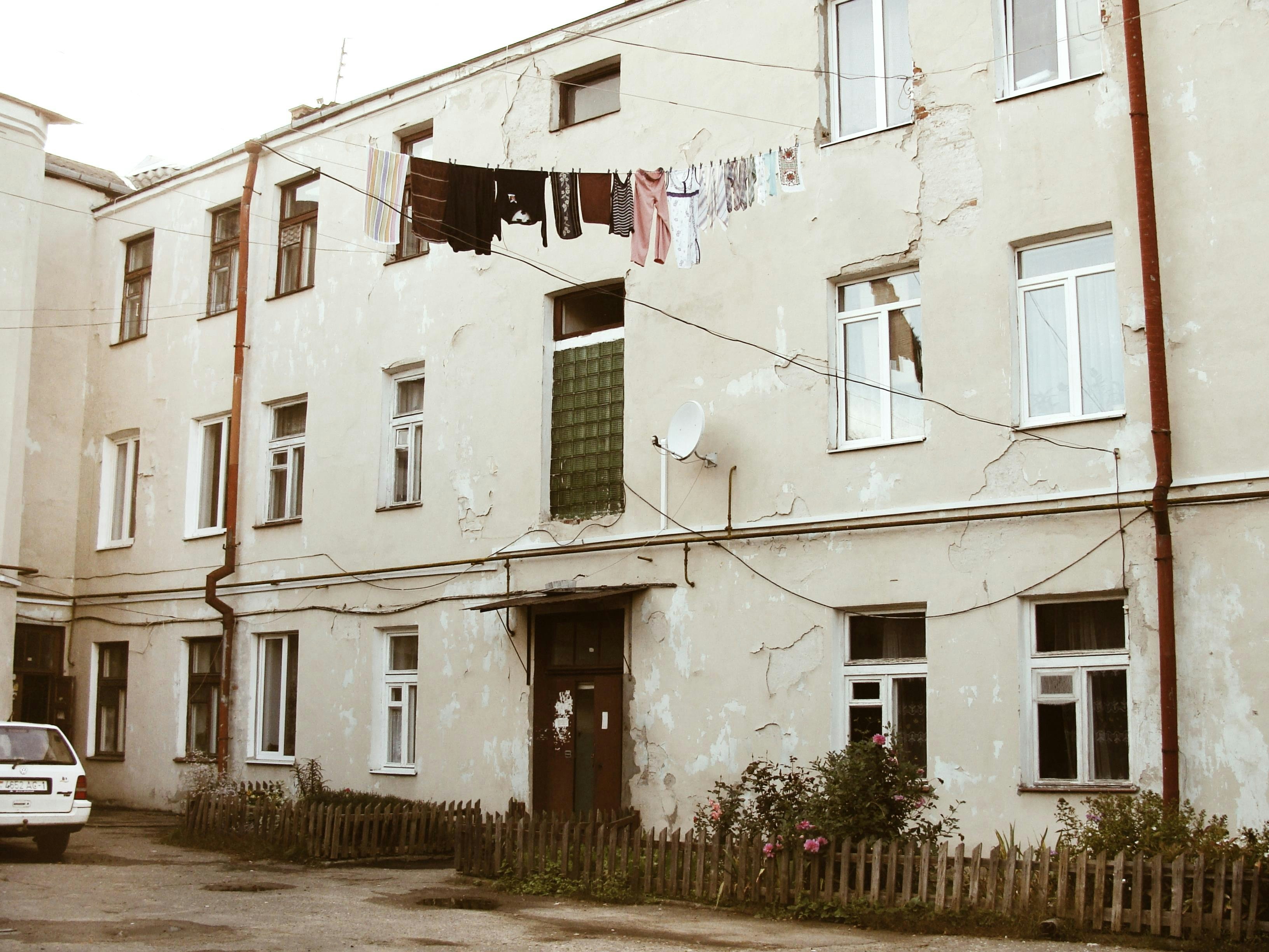 Cracked Facade and Laundry Lines Across a Quiet Courtyard