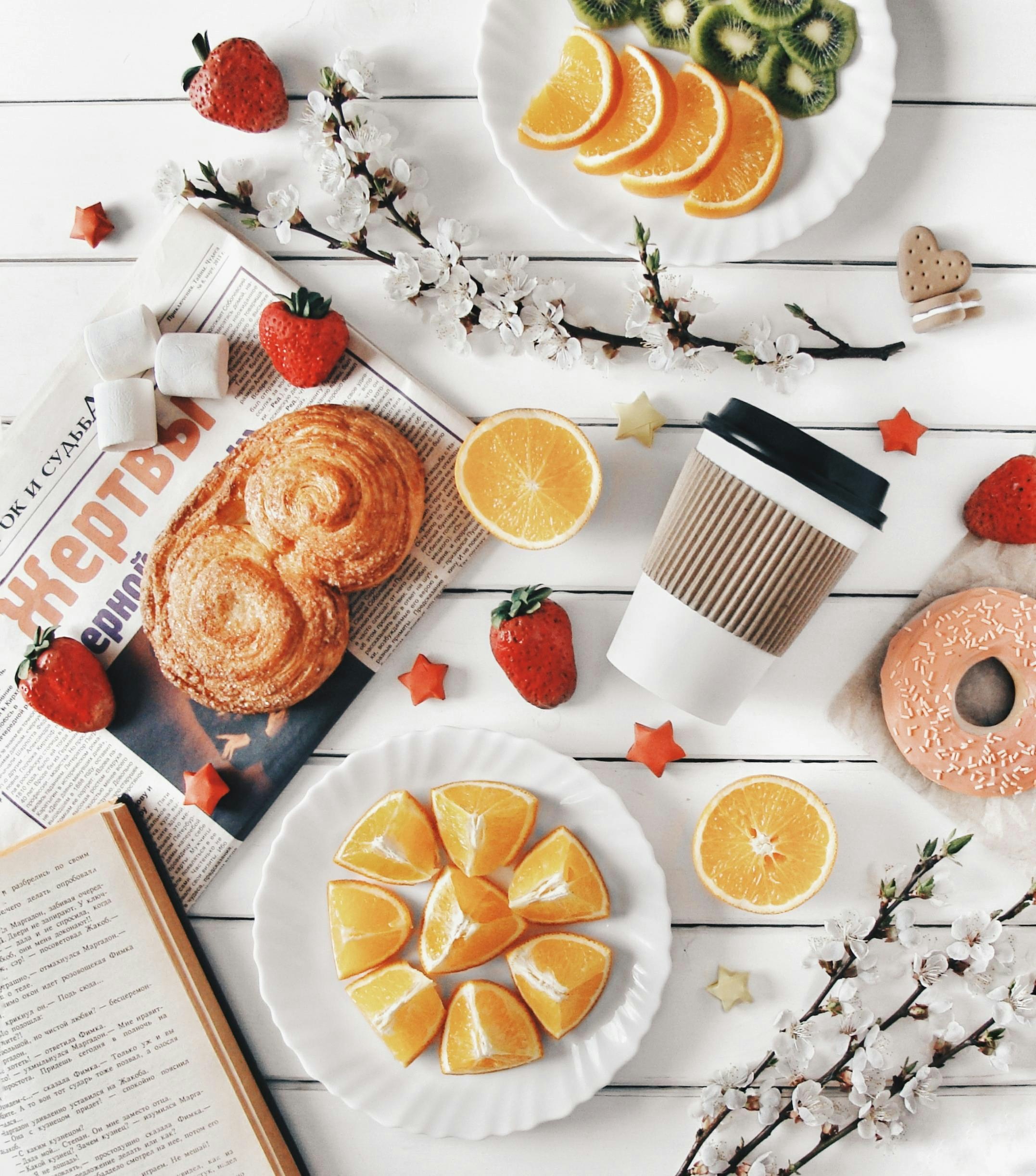 Citrus and Pastry Spread on a White Wooden Table