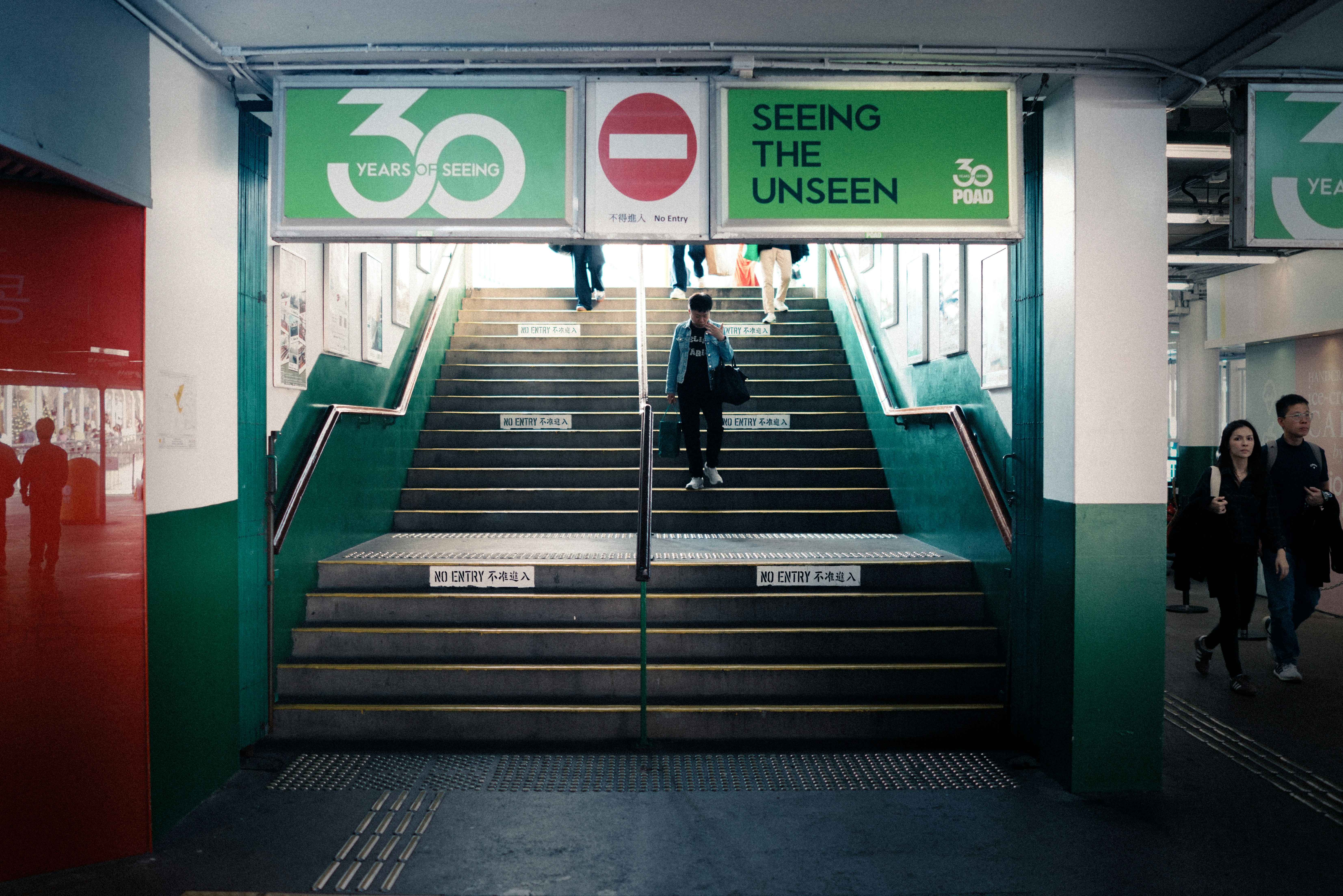 Underground Threshold: A Man Ascends the Green-White Stairway