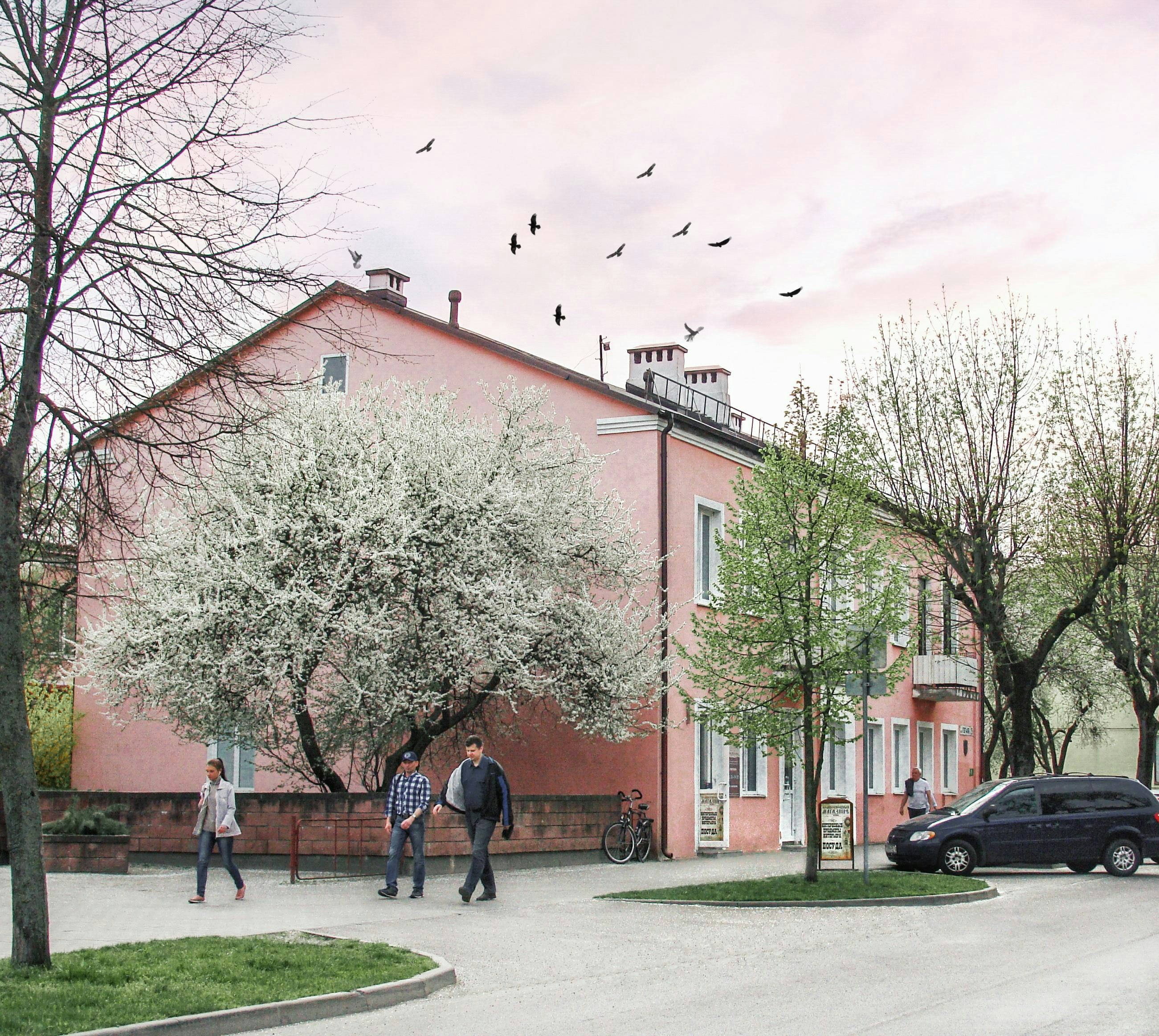 Pastel Facade Boulevard: a pink building and blooming trees along a quiet street