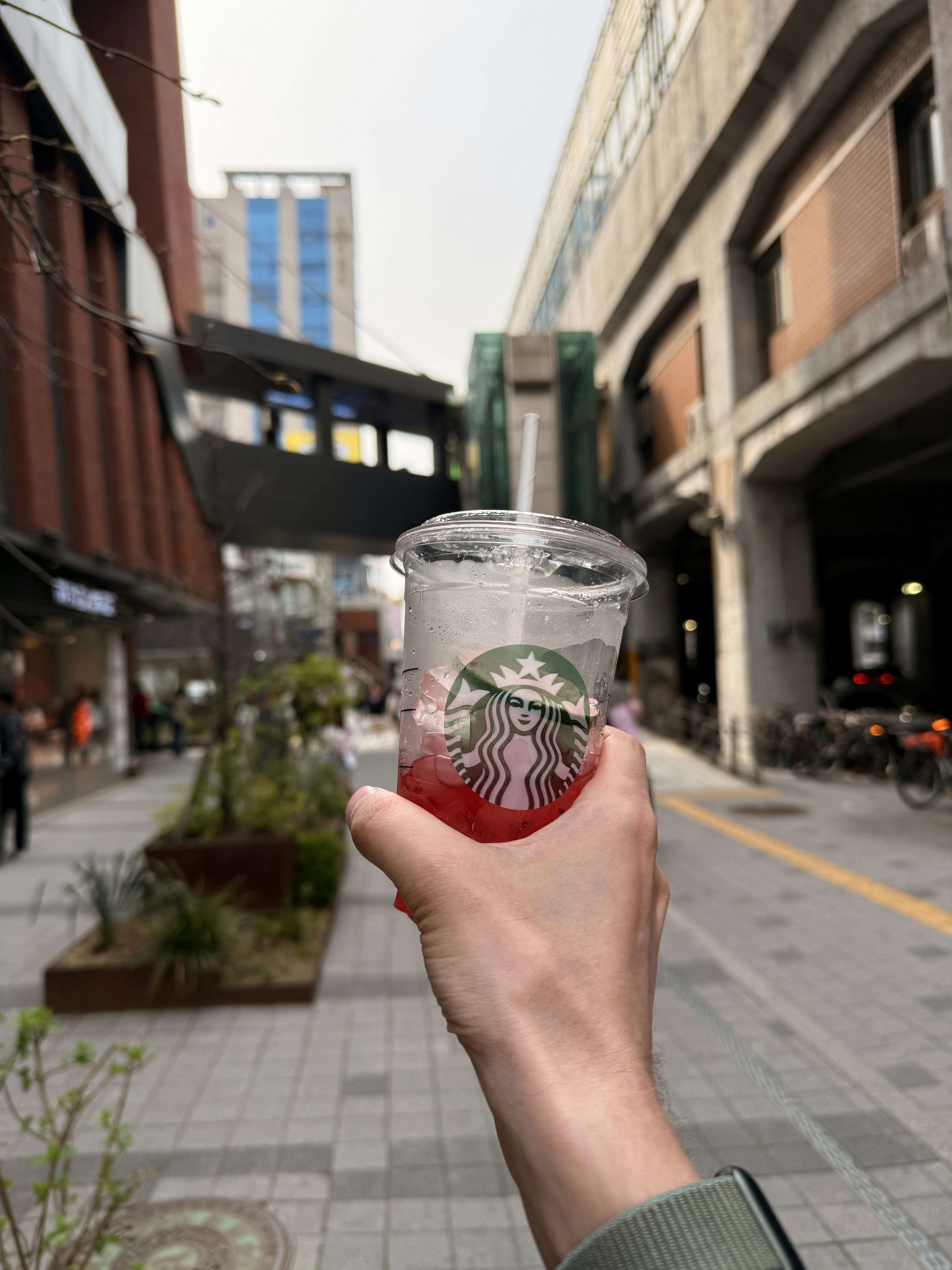 A Hand-Held Starbucks Moment in an Urban Corridor