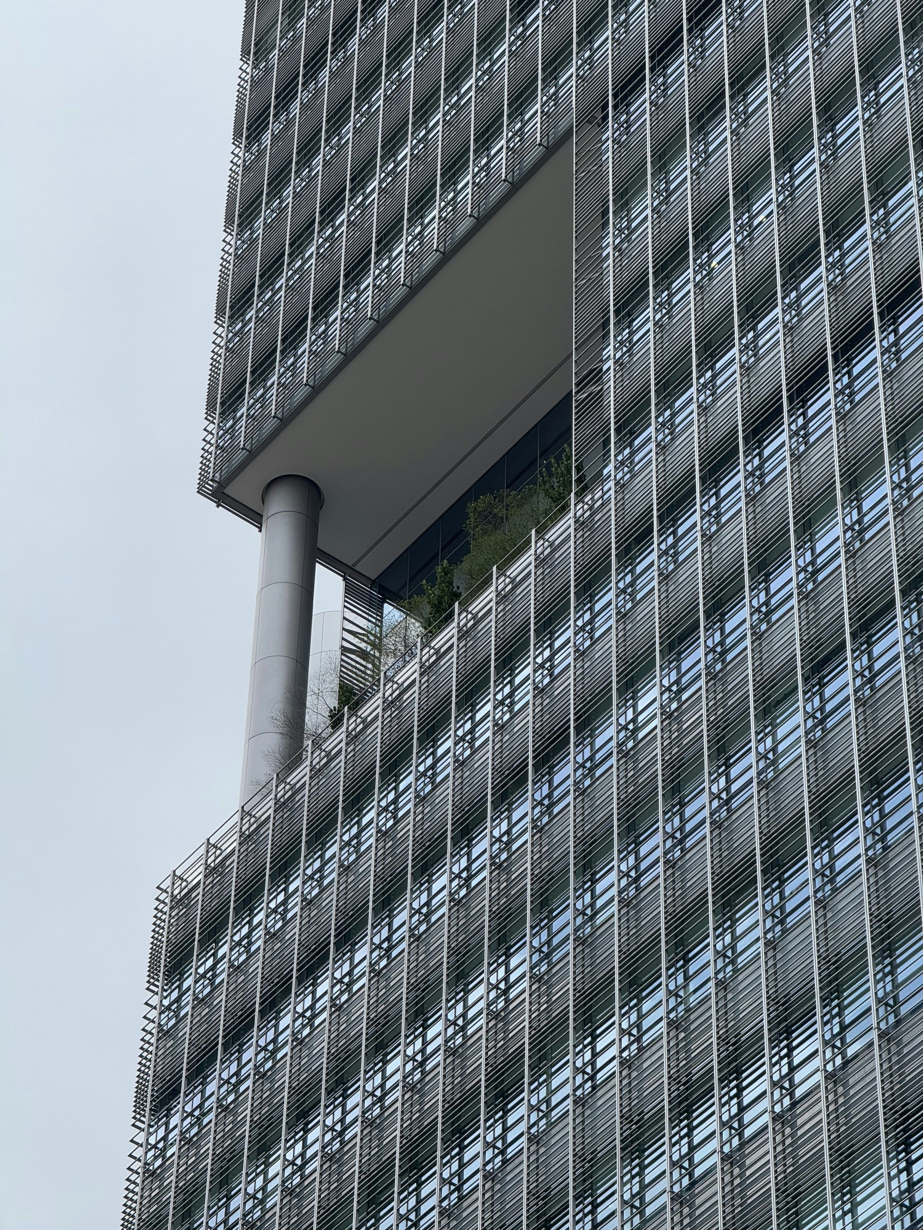 Edge of a Glass-Sheathed Terrace: Vertical Struts and Shadowed Overhang