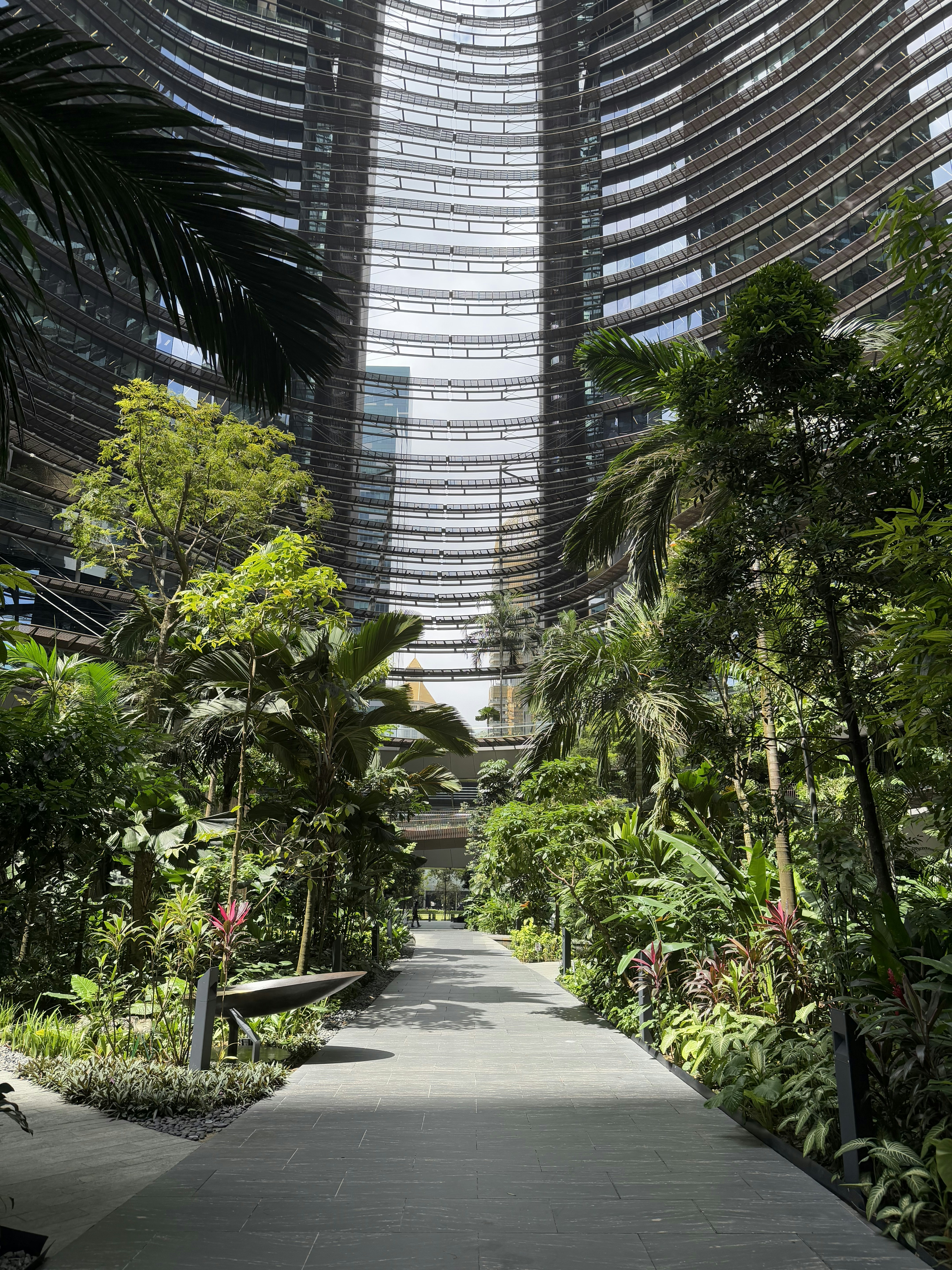 Lush Corridor Inside a Curved Glass Atrium
