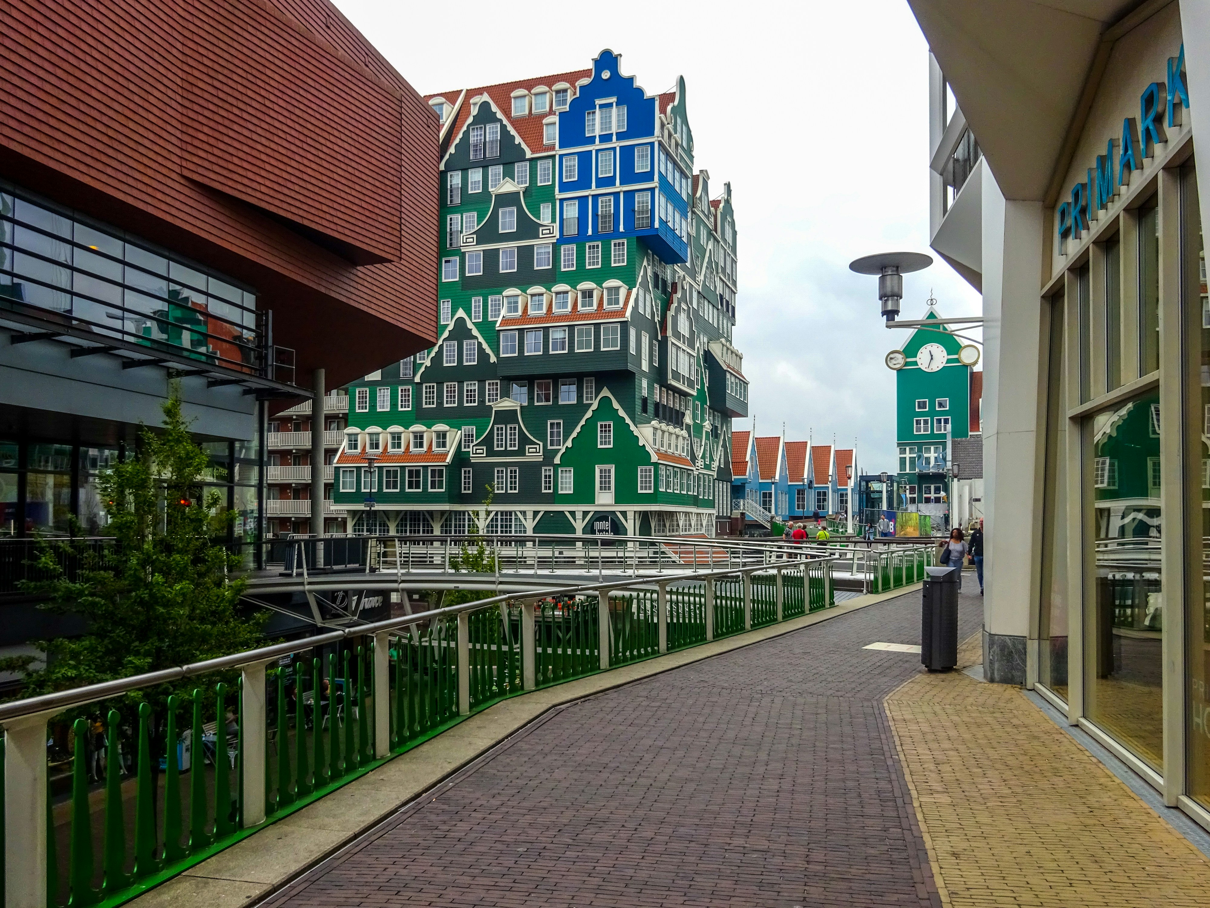 Whimsical stacked houses line a pedestrian promenade