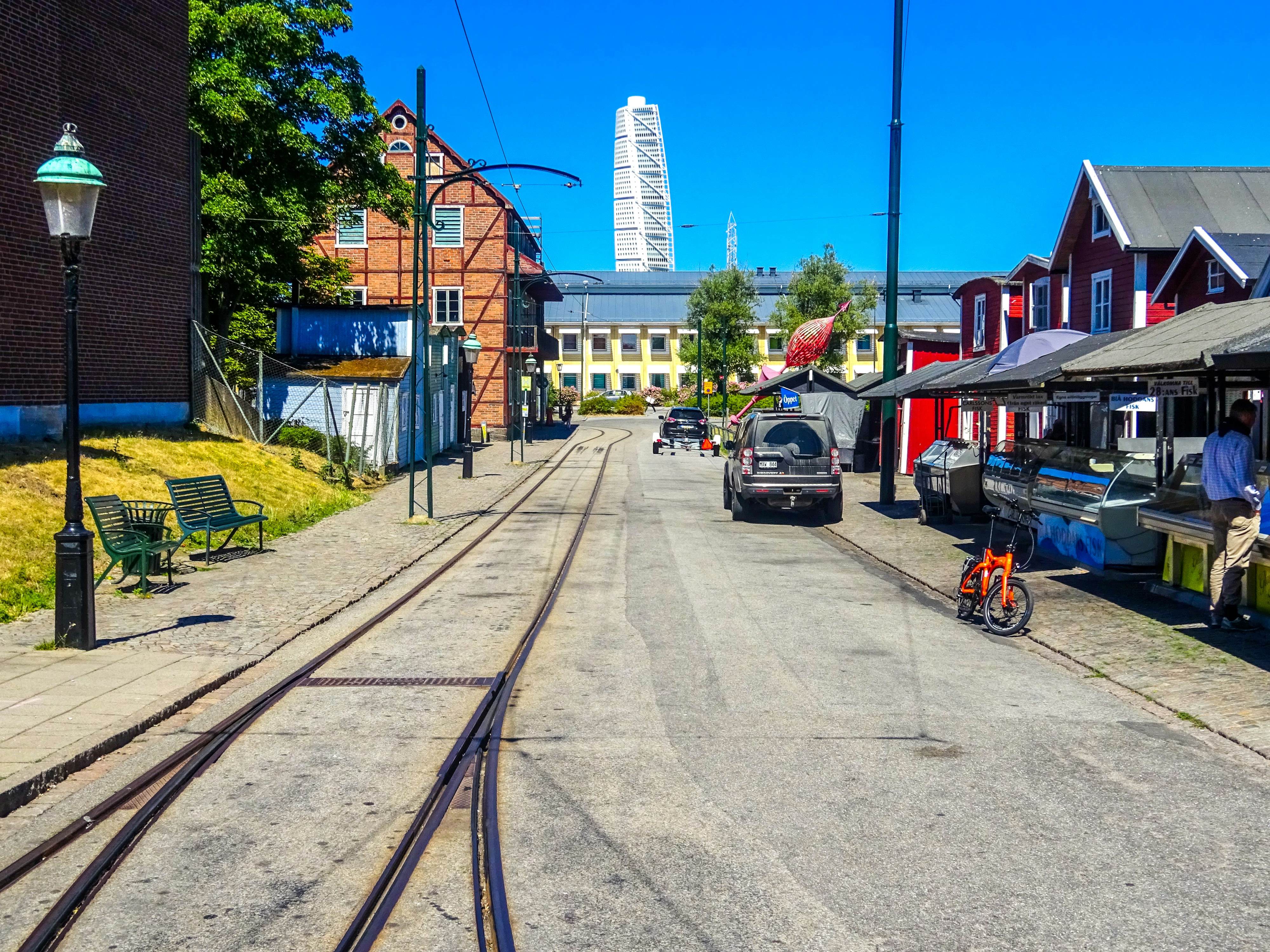 Railyard Street with Waterfront Market Under a Sky-Blue Noon