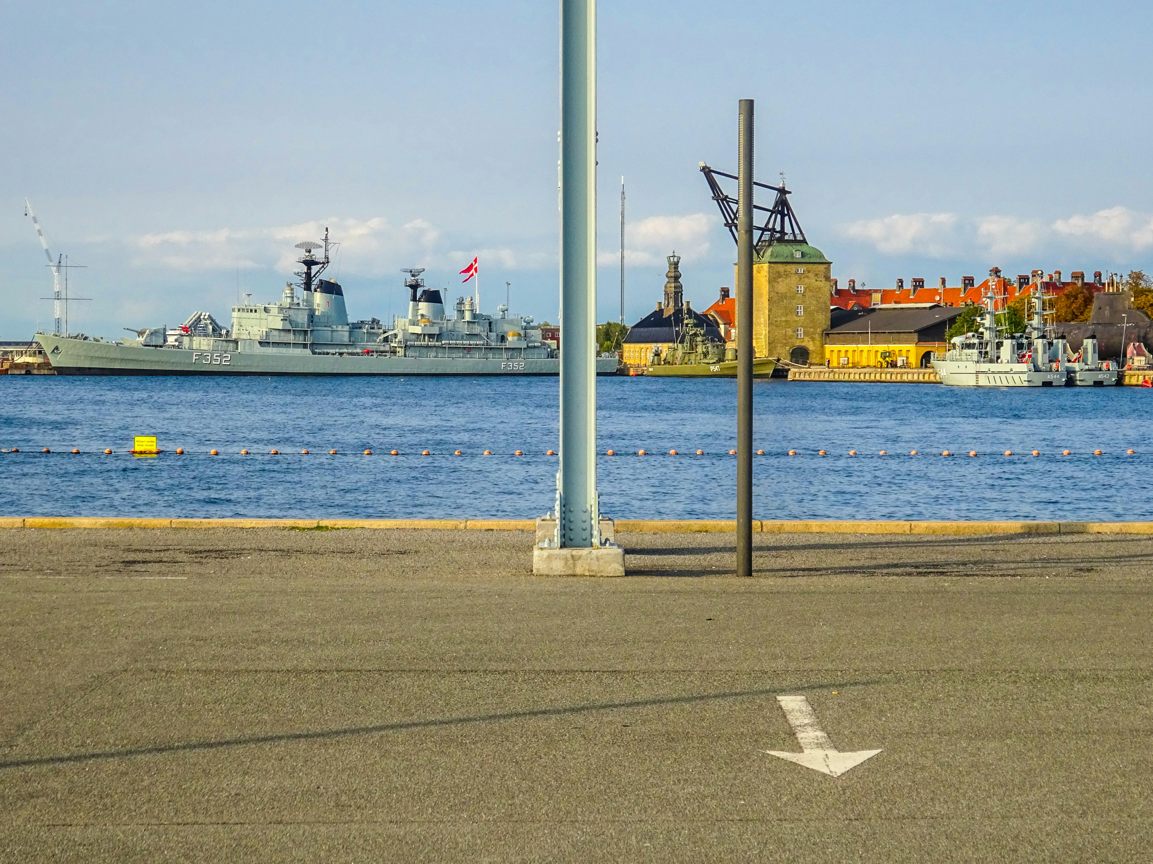 Naval ships docked in a harbor with buildings. photo – Free Boat Image ...