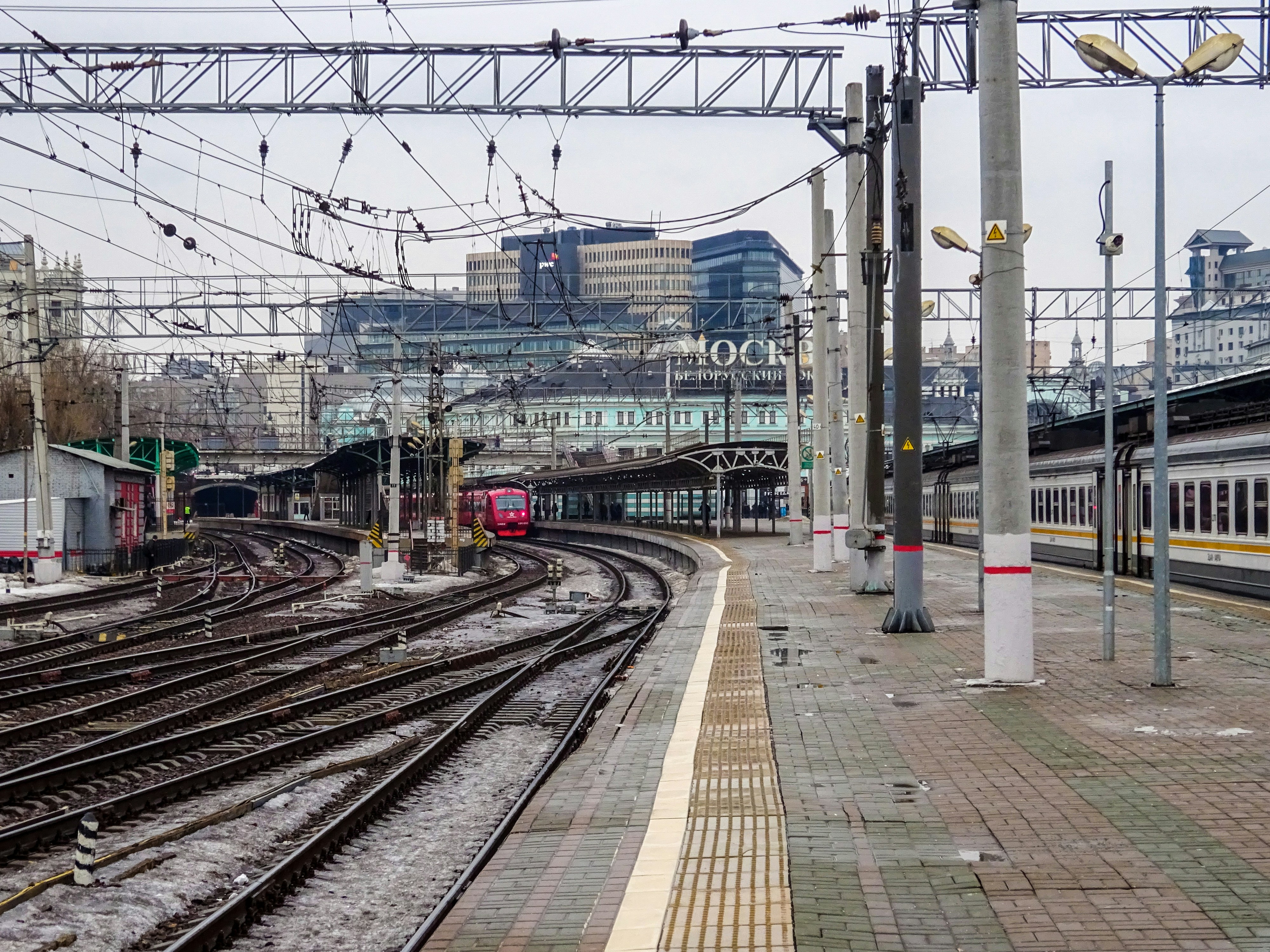 Railway Convergence: Tracks, Platforms and a Distant City Blur