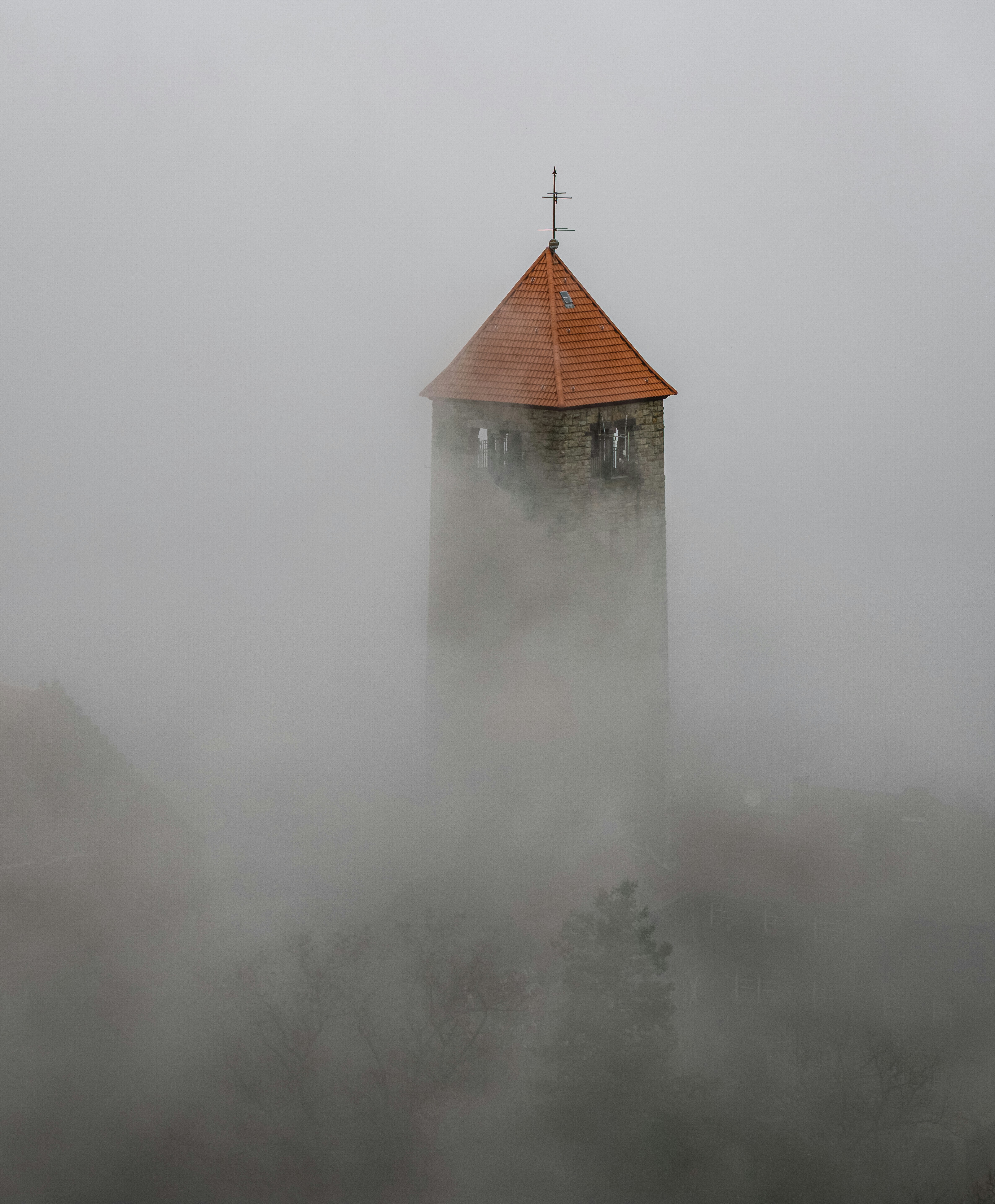 Tower in the Mist: A solitary spire rising through veils of fog