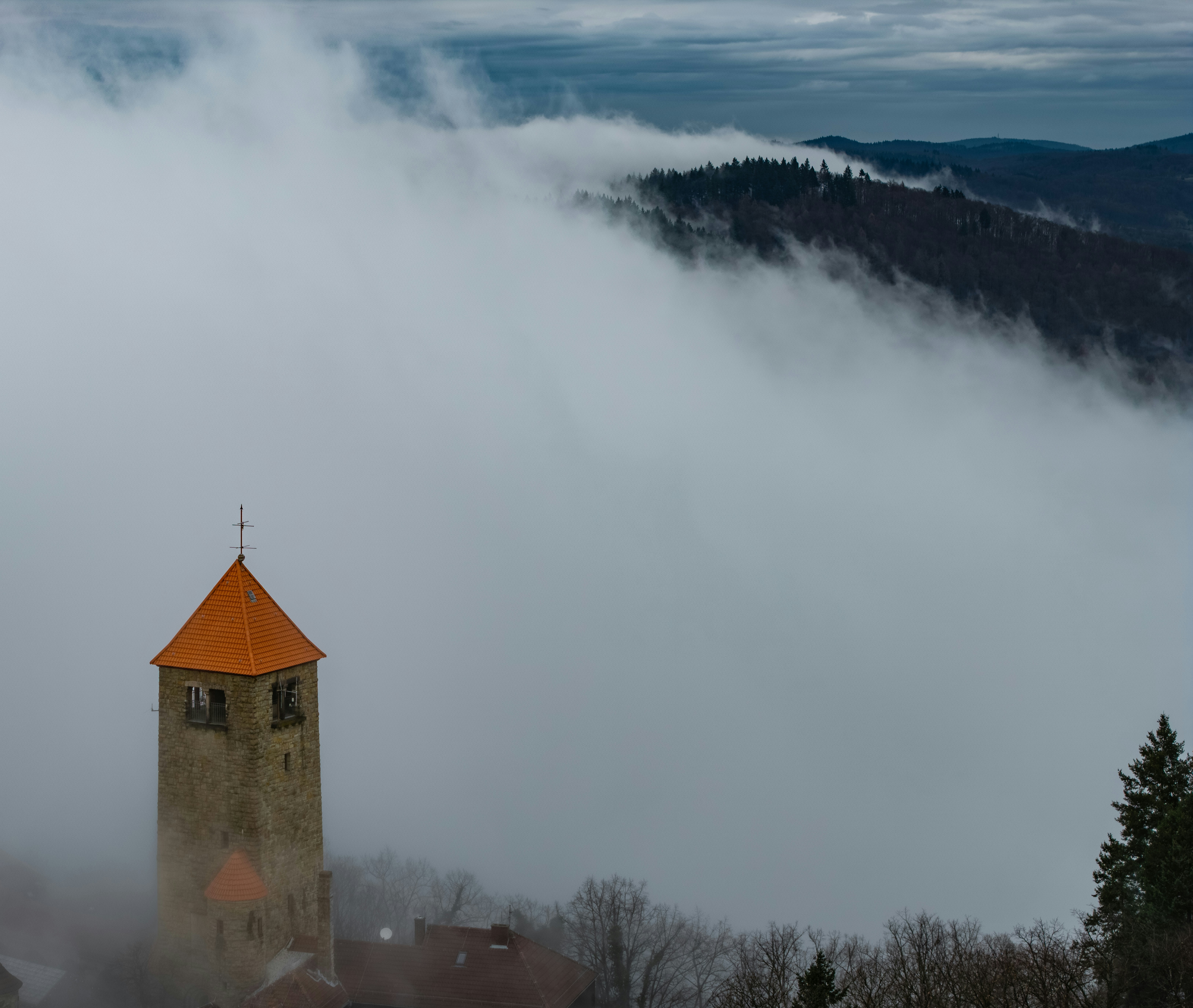 Fog-Lapped Bell Tower Hale Above the Clouds