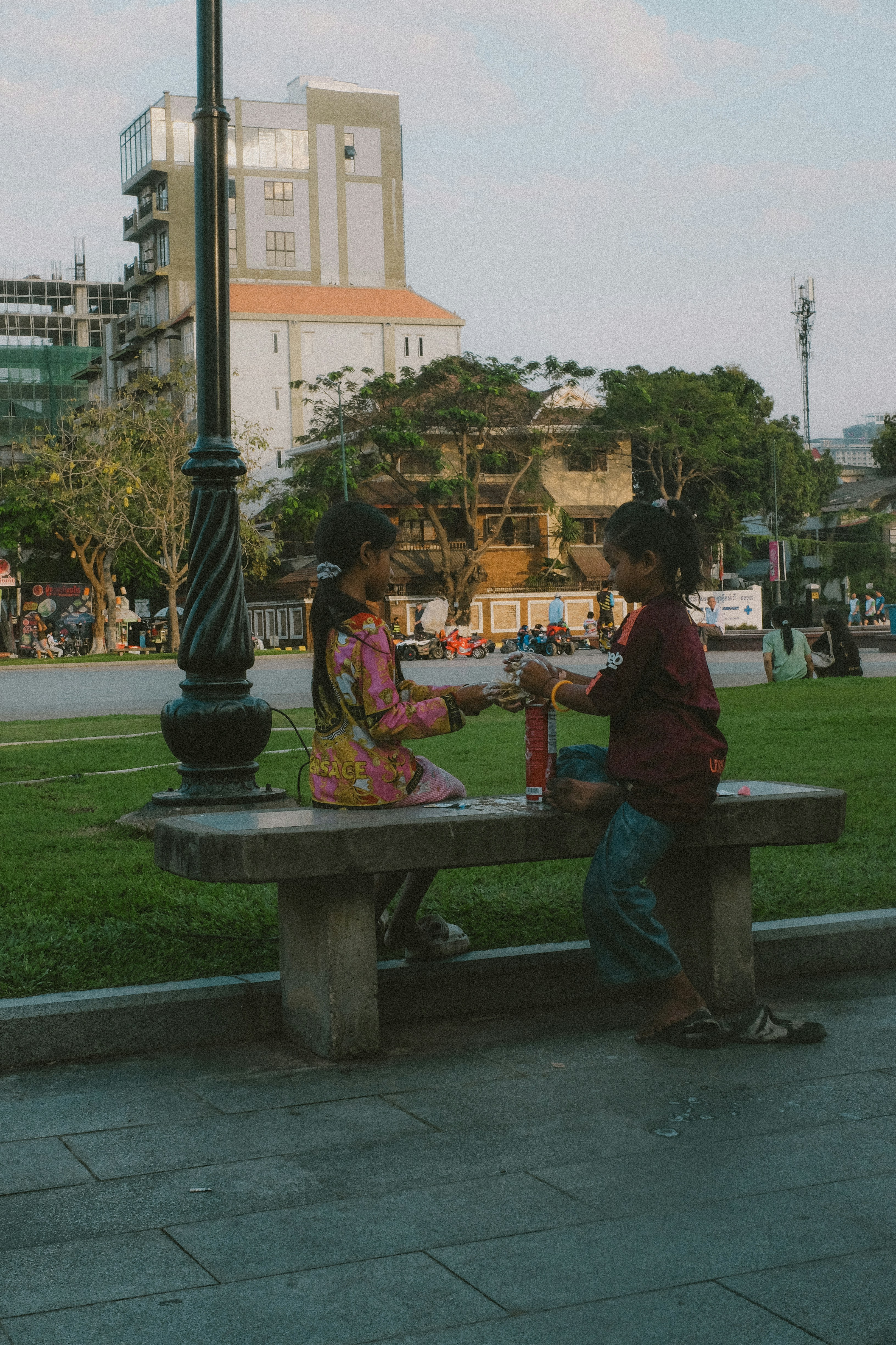 Two Friends on a Park Bench Share a Moment with a Fire Extinguisher