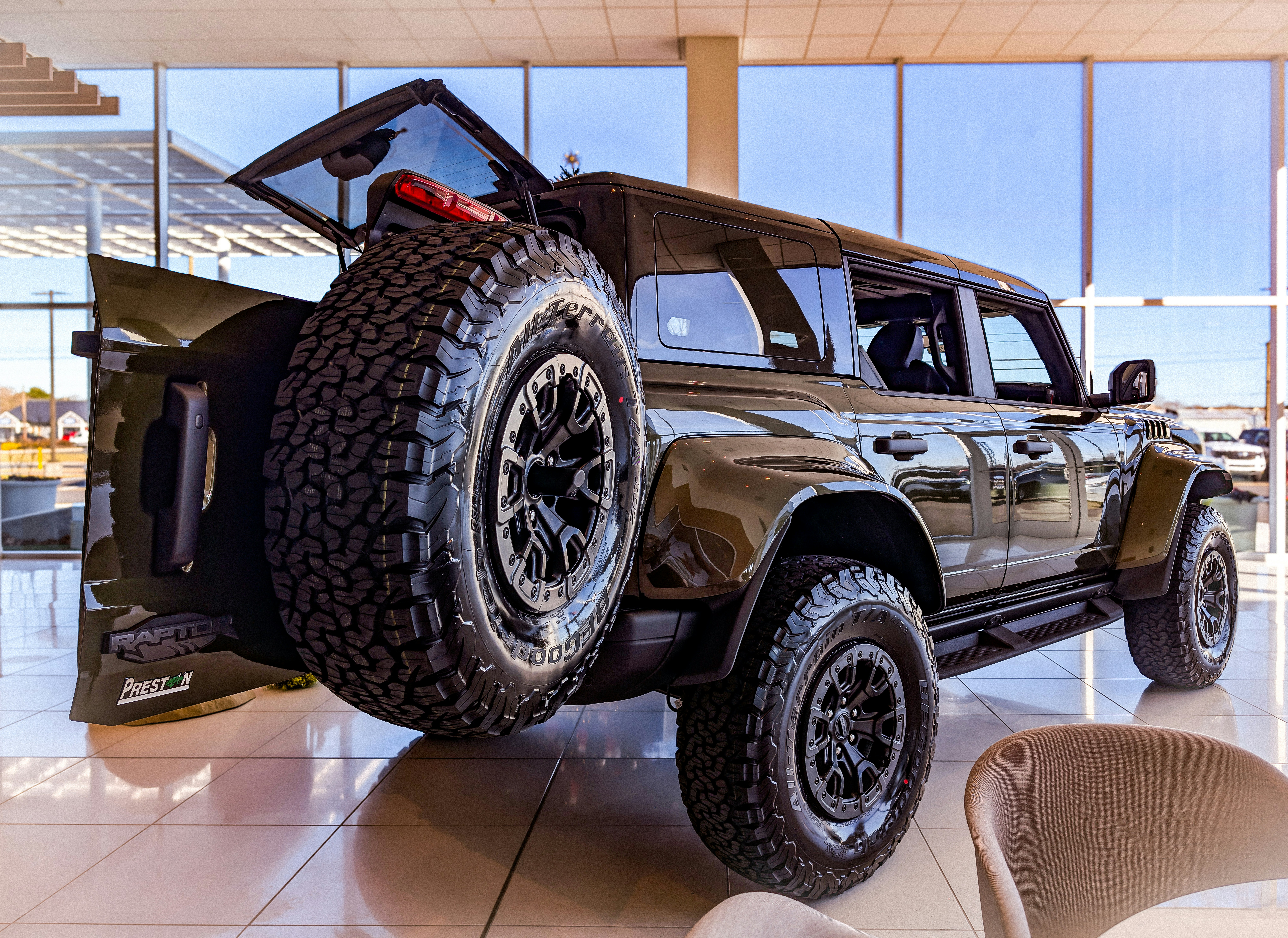 Ford Bronco Raptor radiates raw power and sophisticated elegance. Its massive tires and rugged stance command attention, while the pristine showroom setting highlights every magnificent, sun-drenched architectural detail. Boulevard Ford.