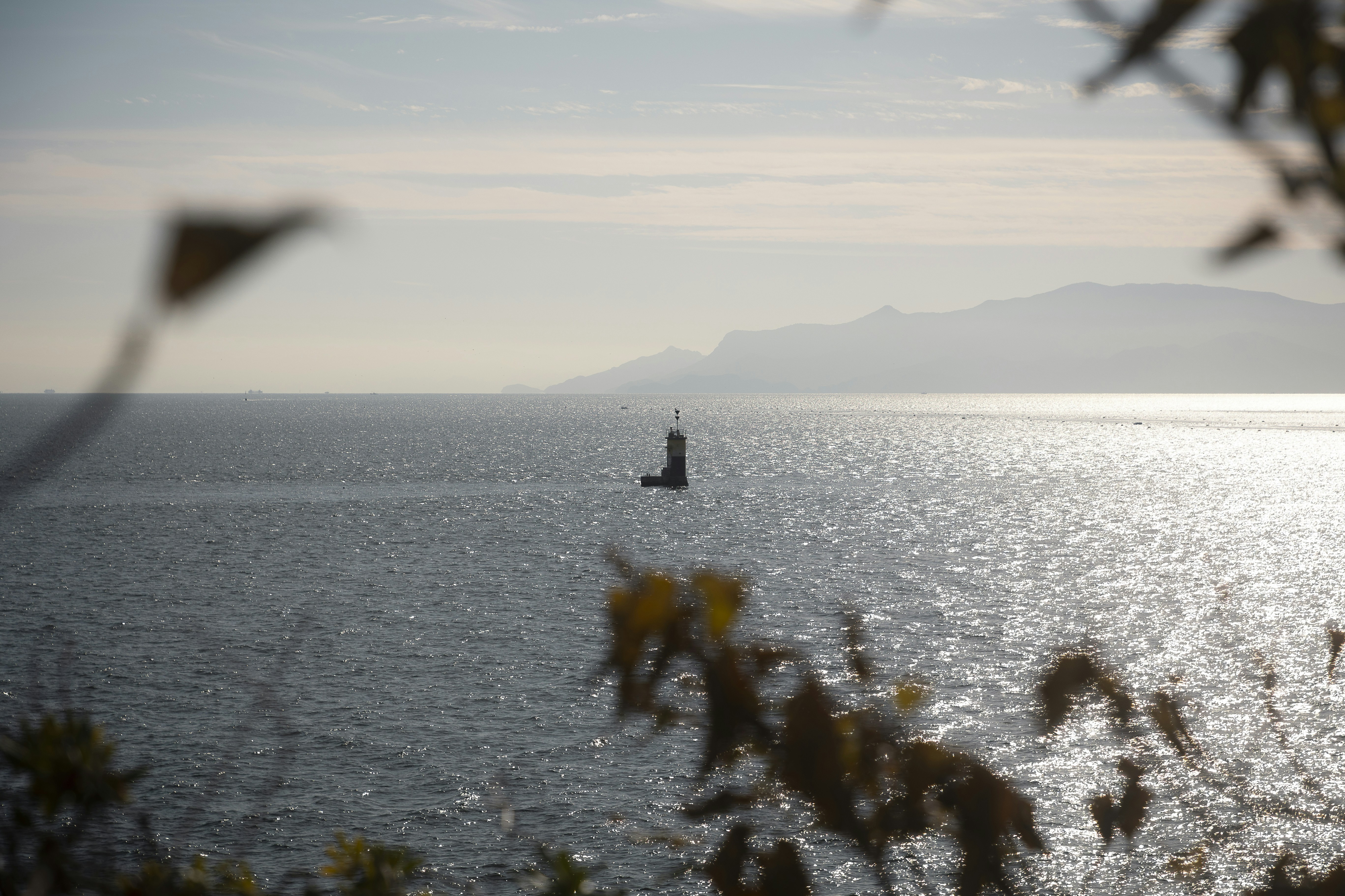 Harbor Light: A Lone Beacon Beside the Distant Coast