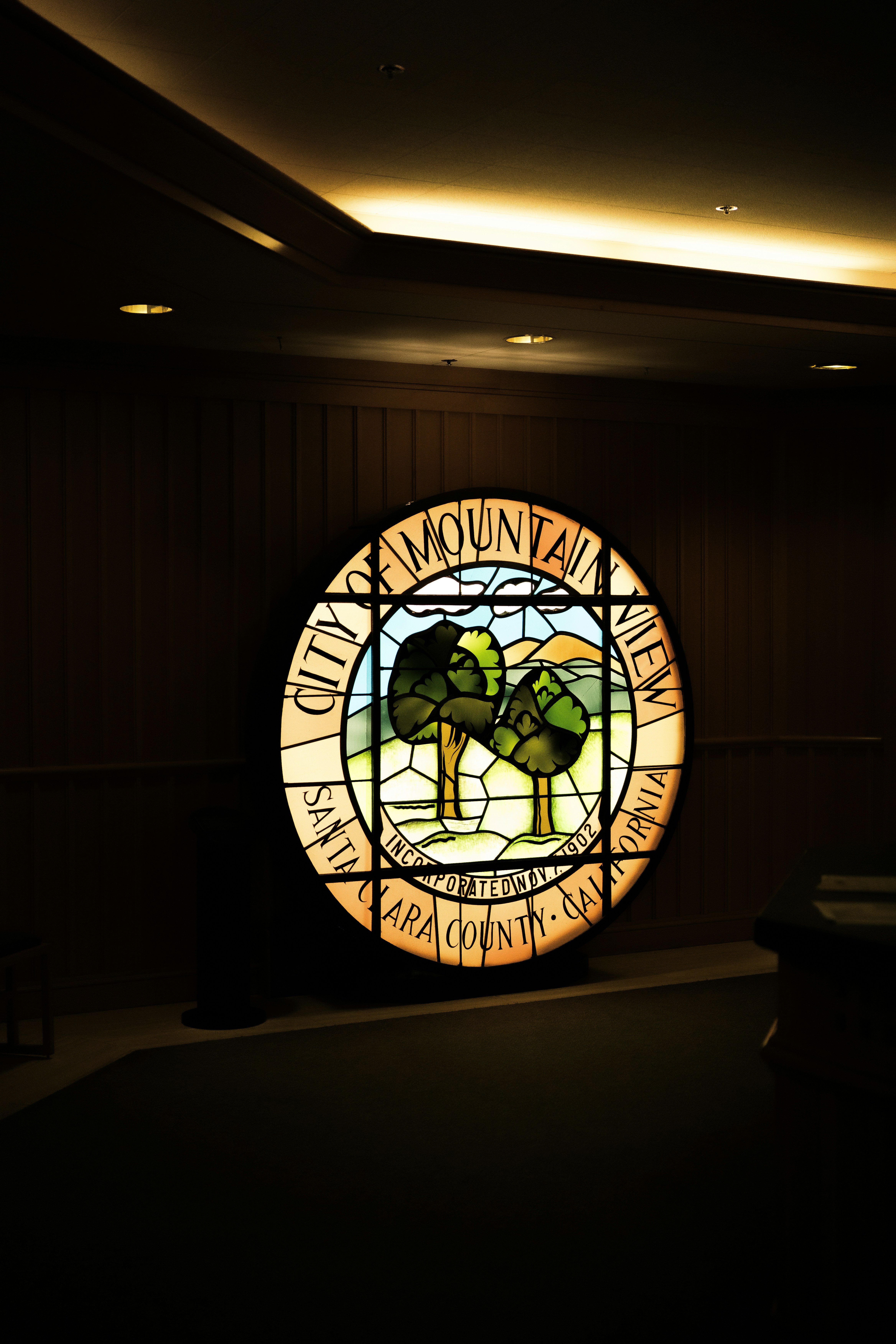 Stained Glass Circles: City Seal Illuminated in a Dim Lobby