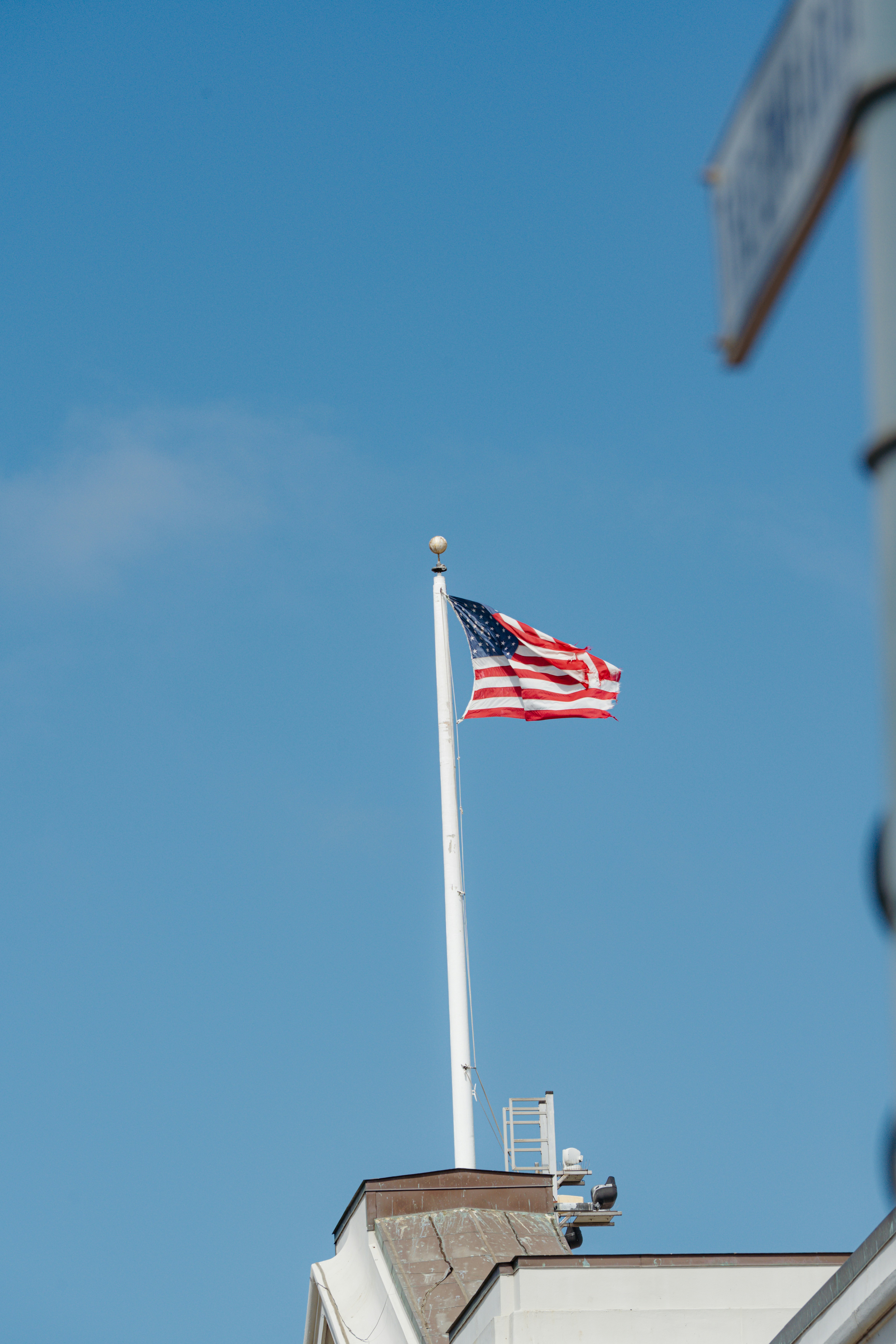 Flag Above the Rooftop, Under a Clear Blue Sky
