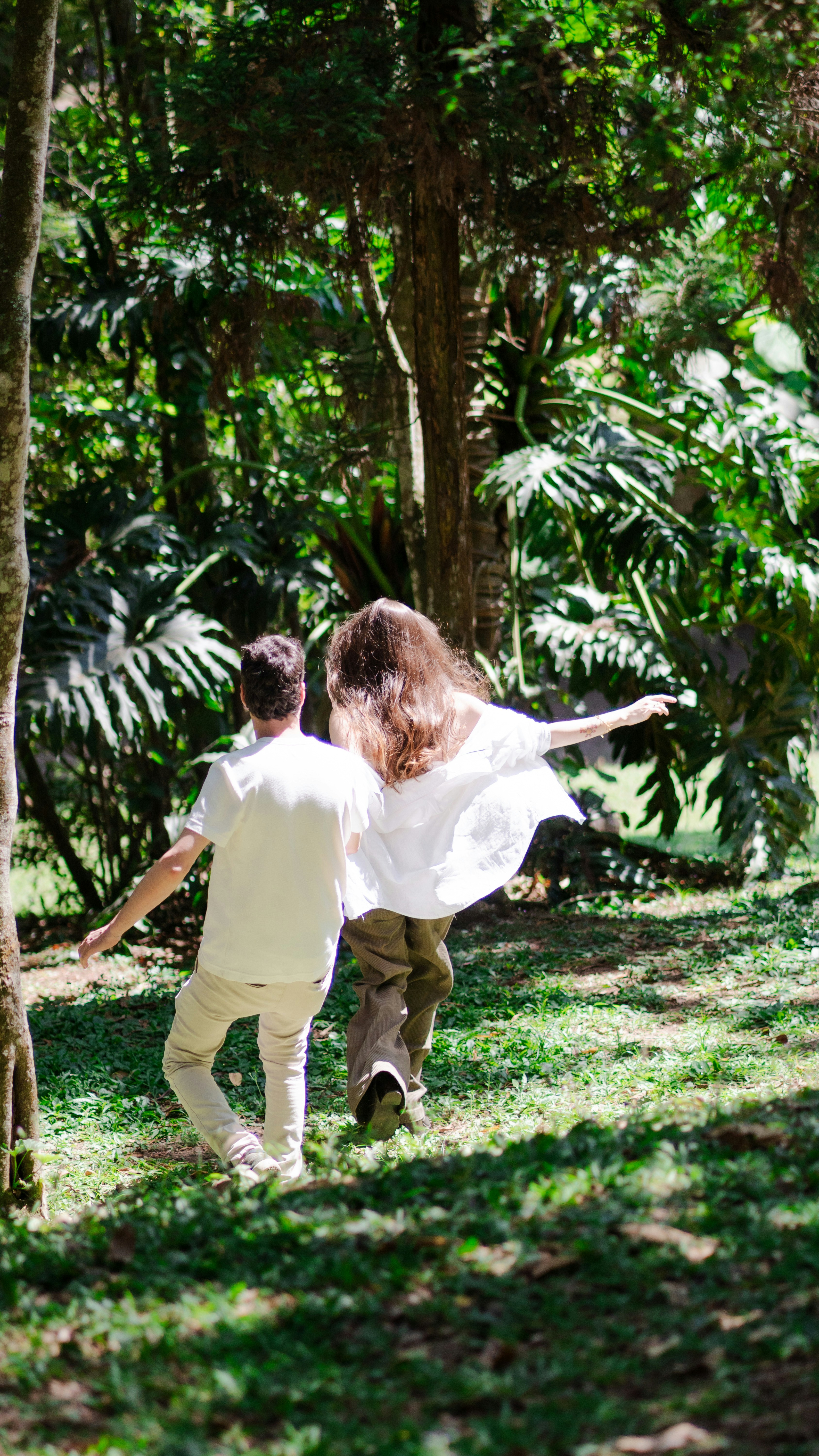Forest Escape: Two Children in Flight Among Circling Light