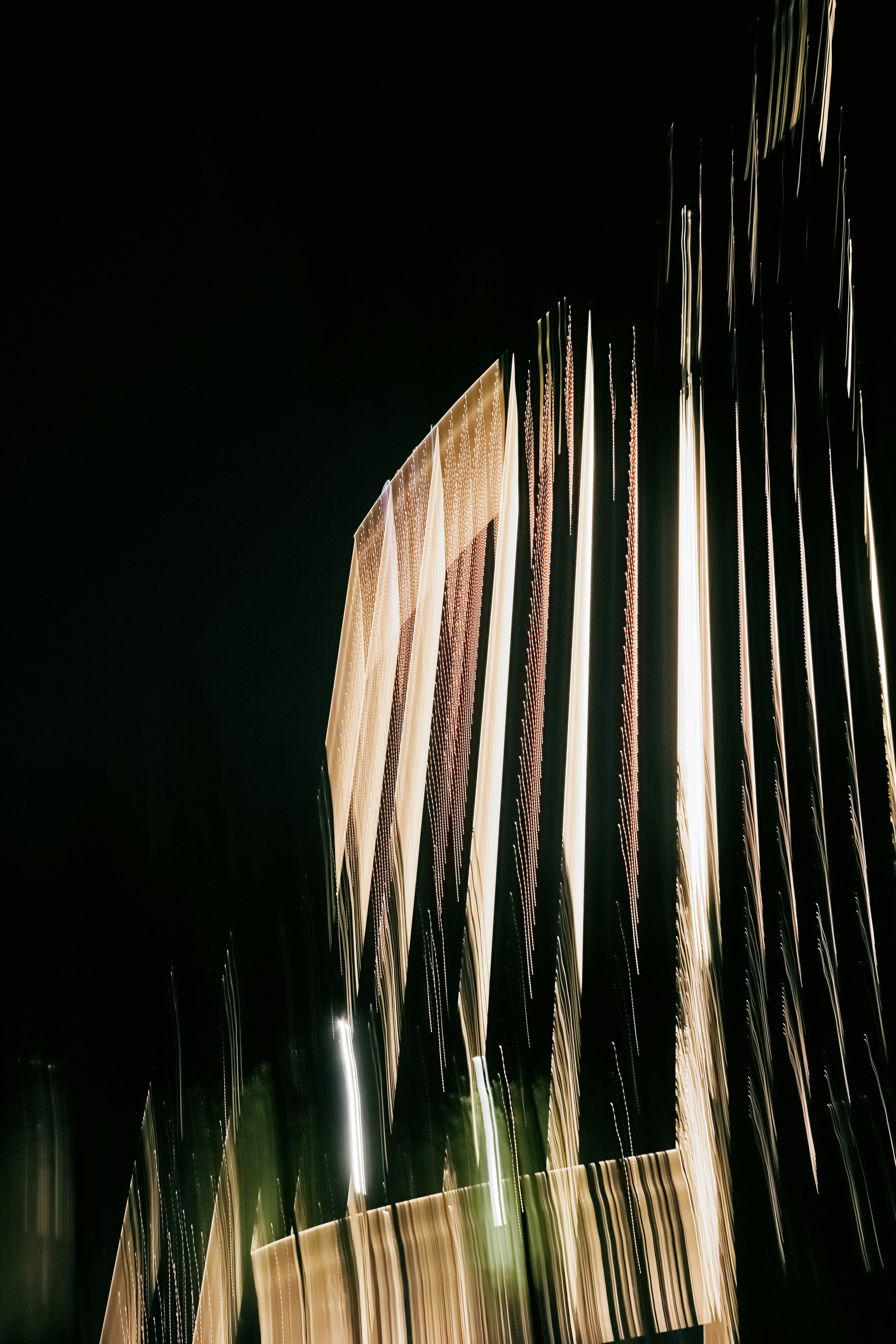 Neon waterfall of light on a dark city night