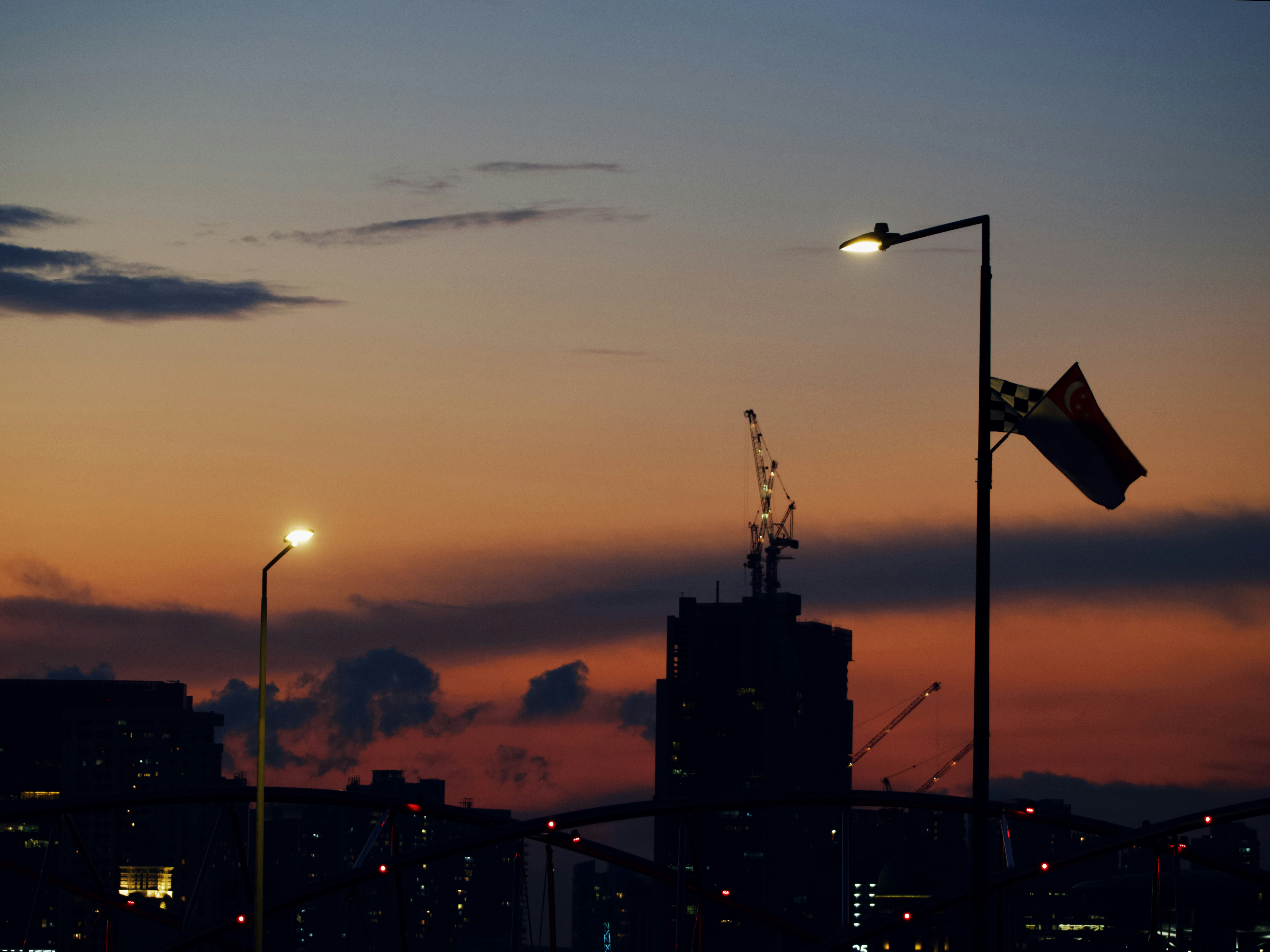 Crane Skyline at Dusk: A City Quietly Wears Its Lanterns