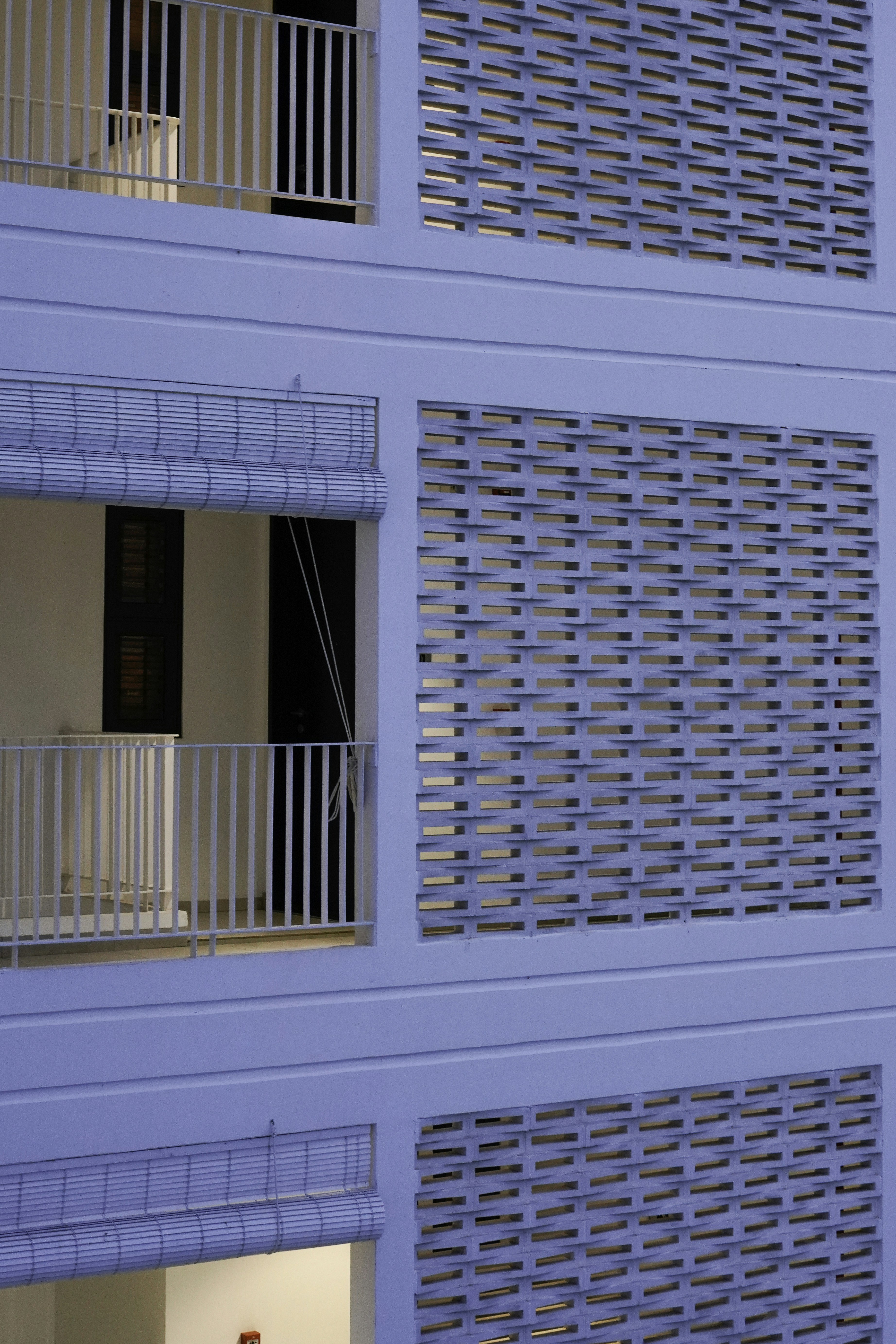 Patterned Light and Shadow on a Blue Balustrade Facade