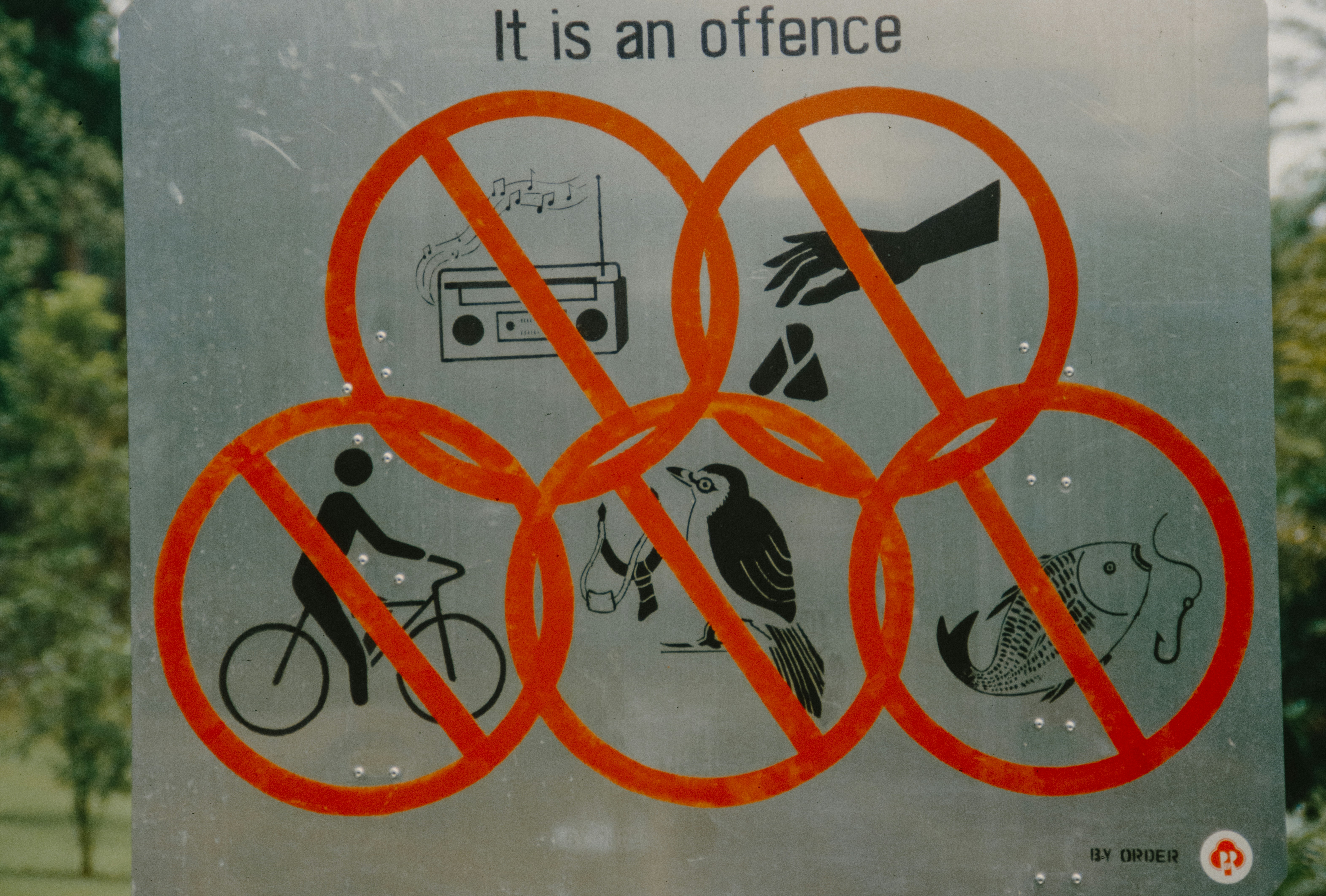 Park rules sign with five prohibition symbols.