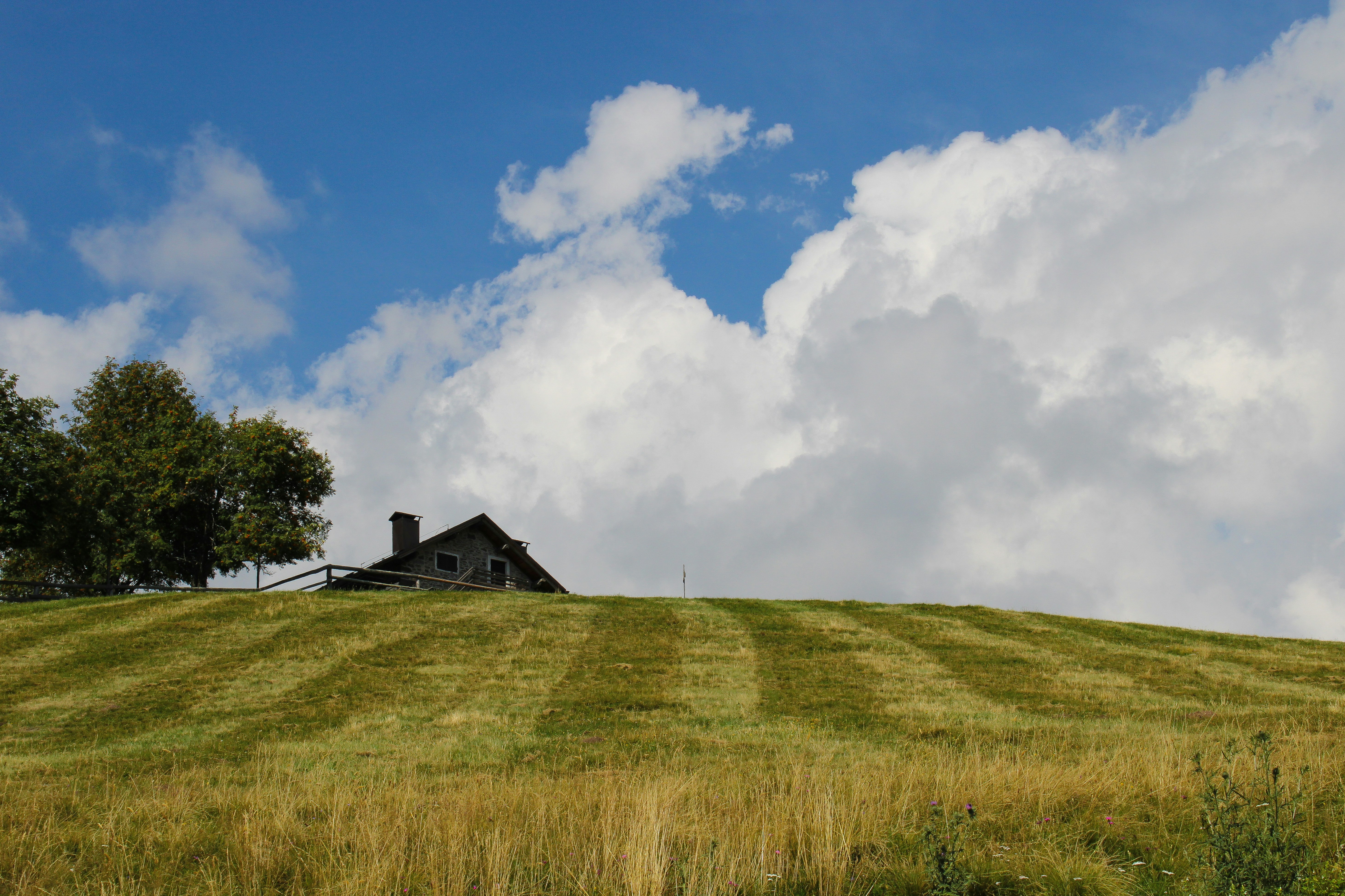 Hilltop Cabin Under A Dramatic Sky