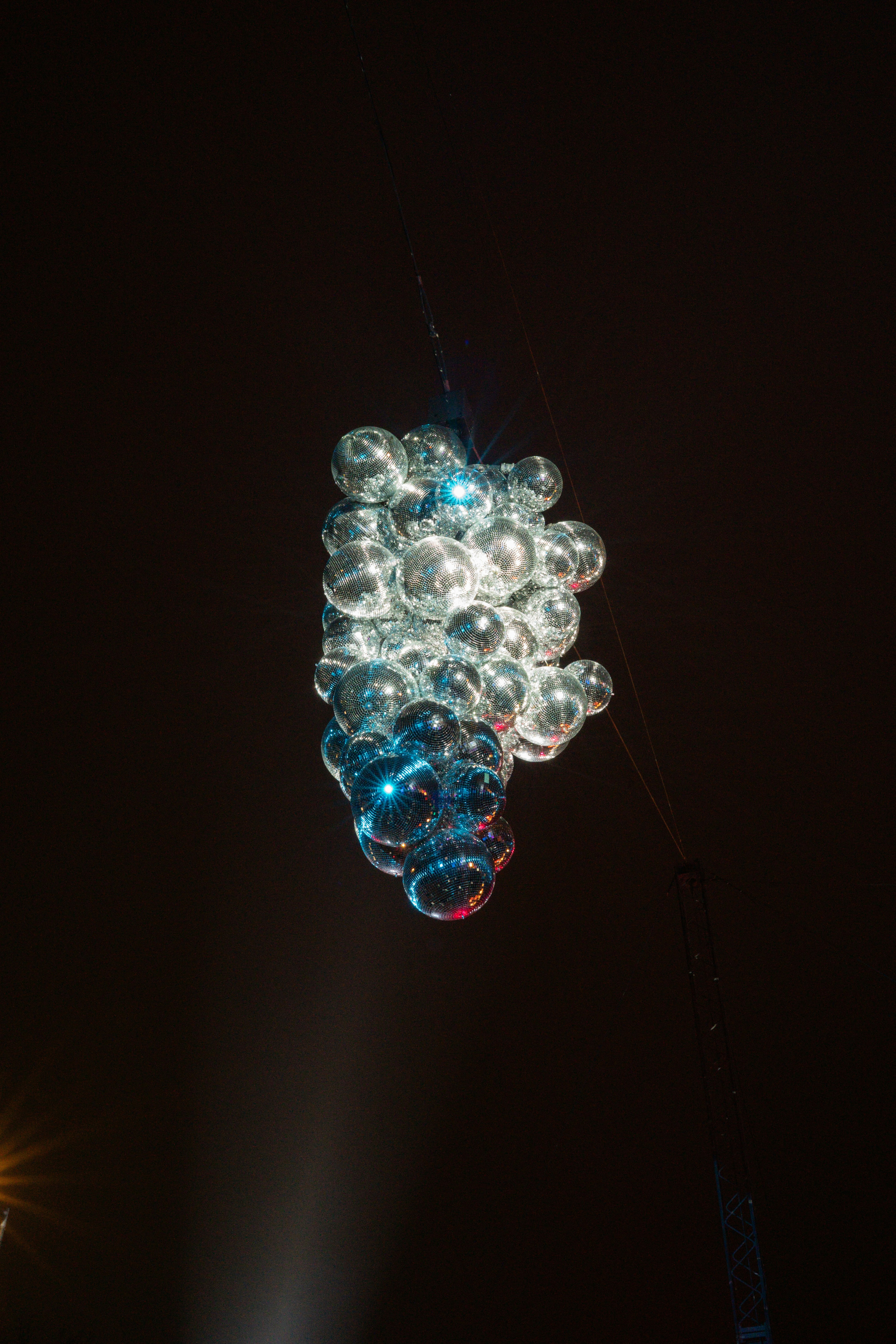 Glowing Bubble Cluster Lifted by Night Crane