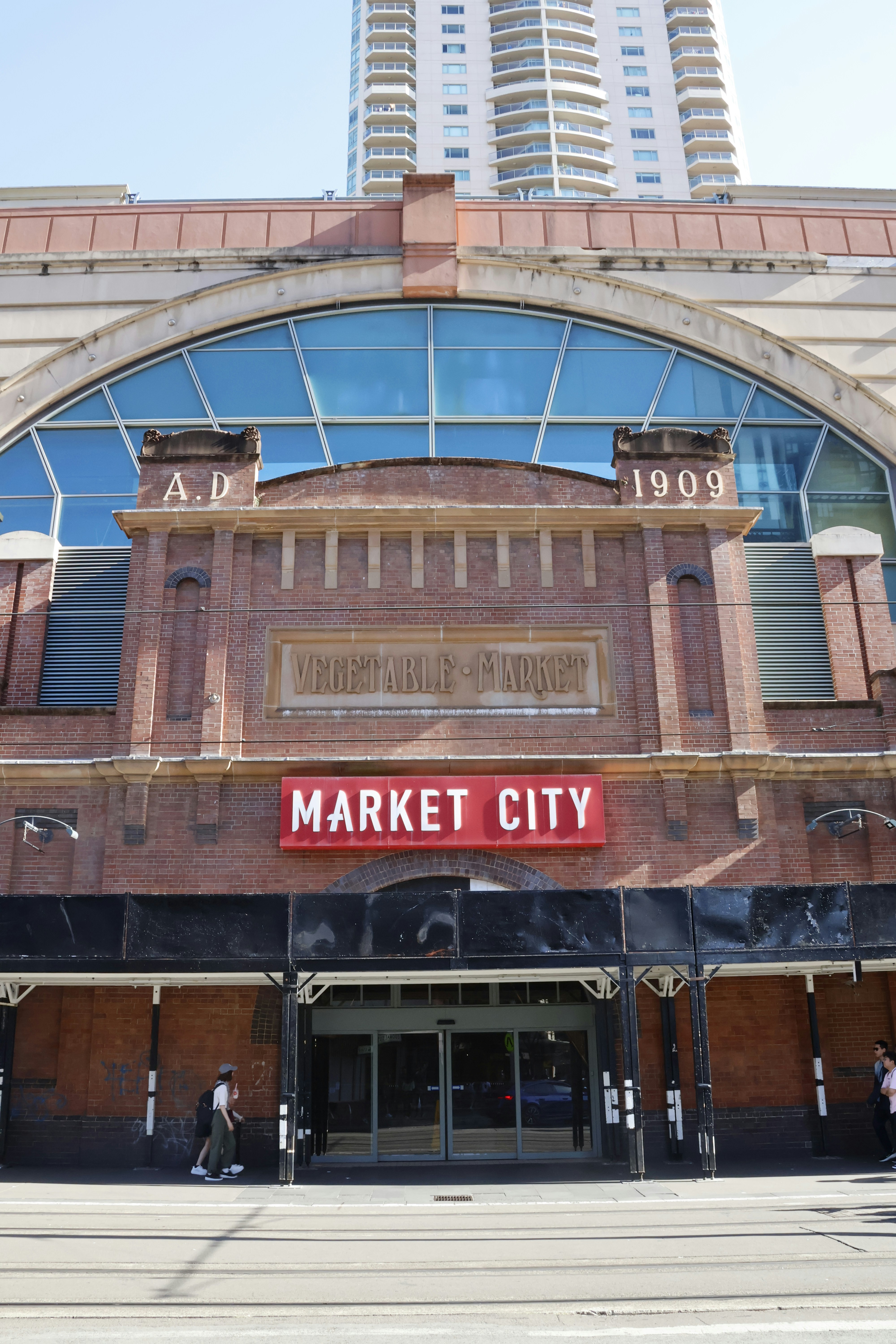 Brick Facade of Market City: Historic Signage Beneath a Glass Arch