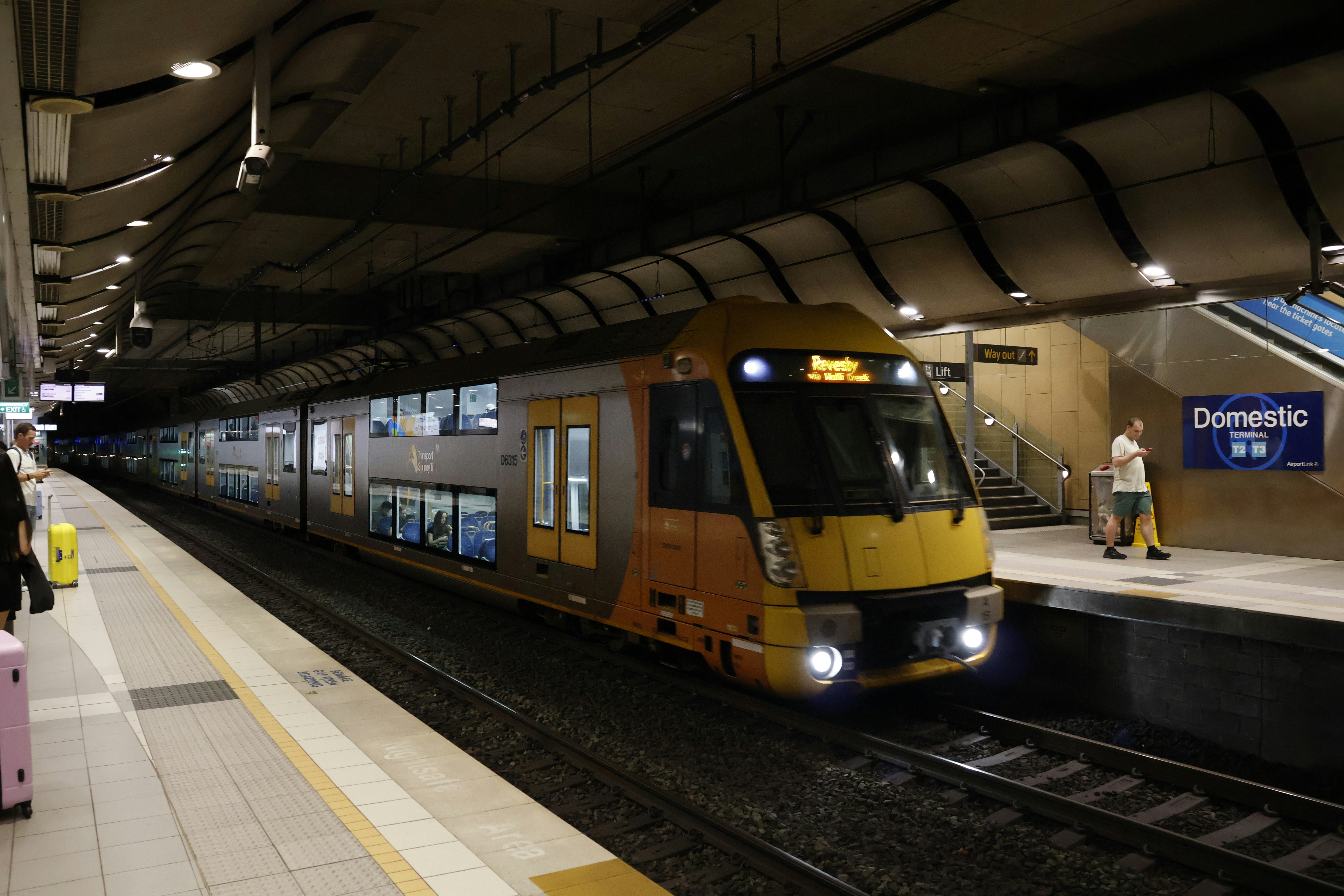 Orange Commuter in the Night Train Station