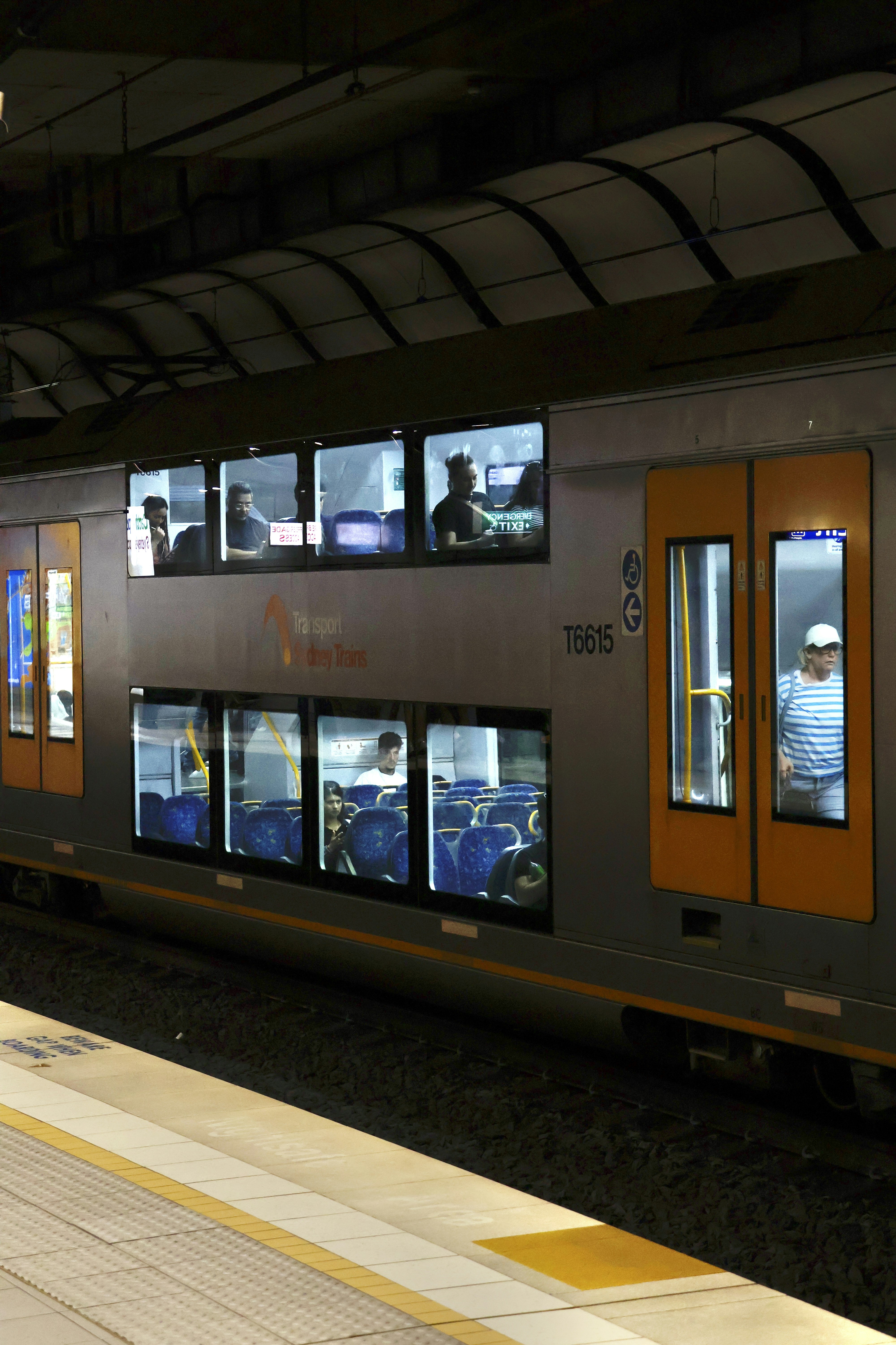 Double-decker train at a station platform at night. photo – Free Travel ...
