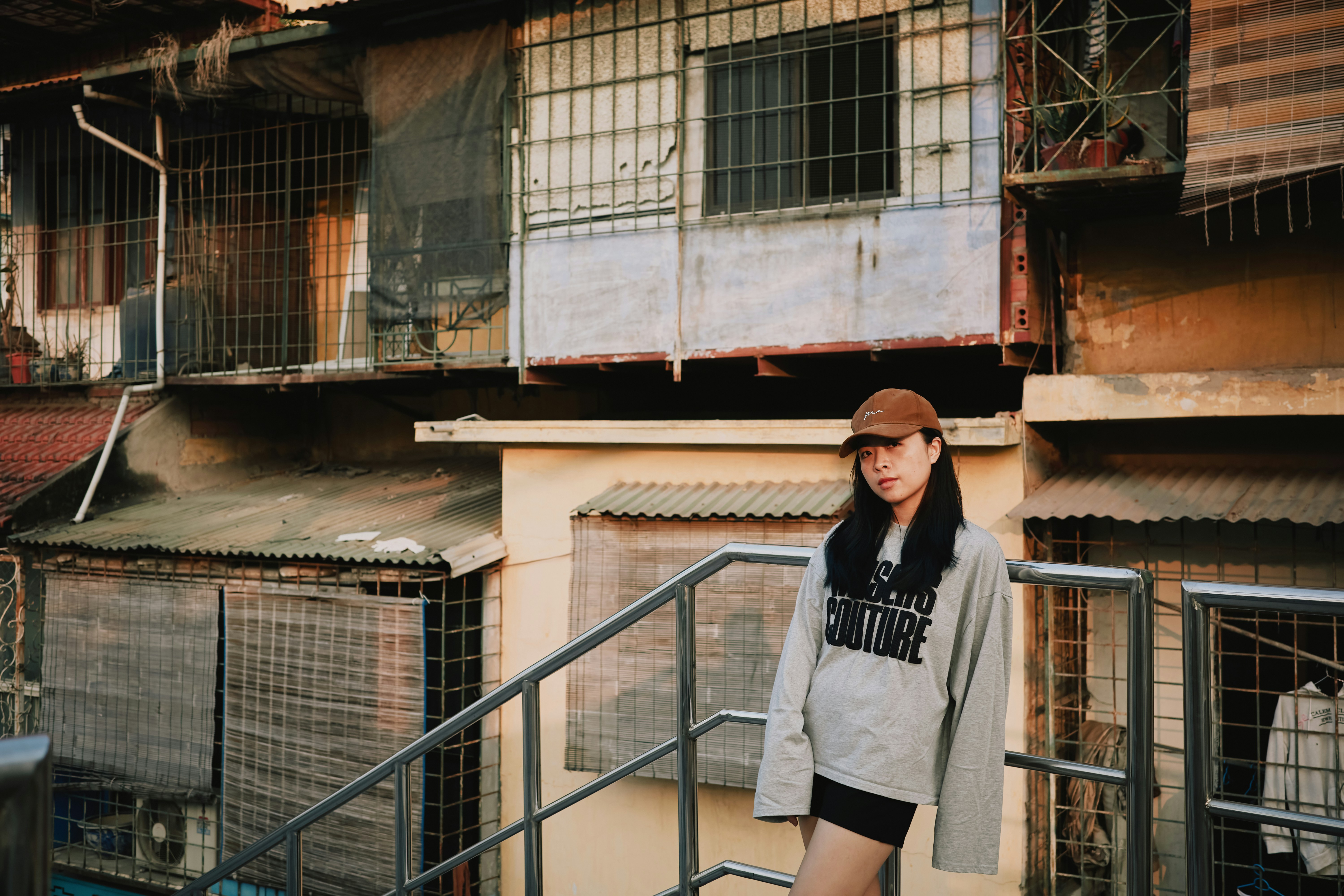 Young woman in casual clothes stands on outdoor stairs. photo – Free ...
