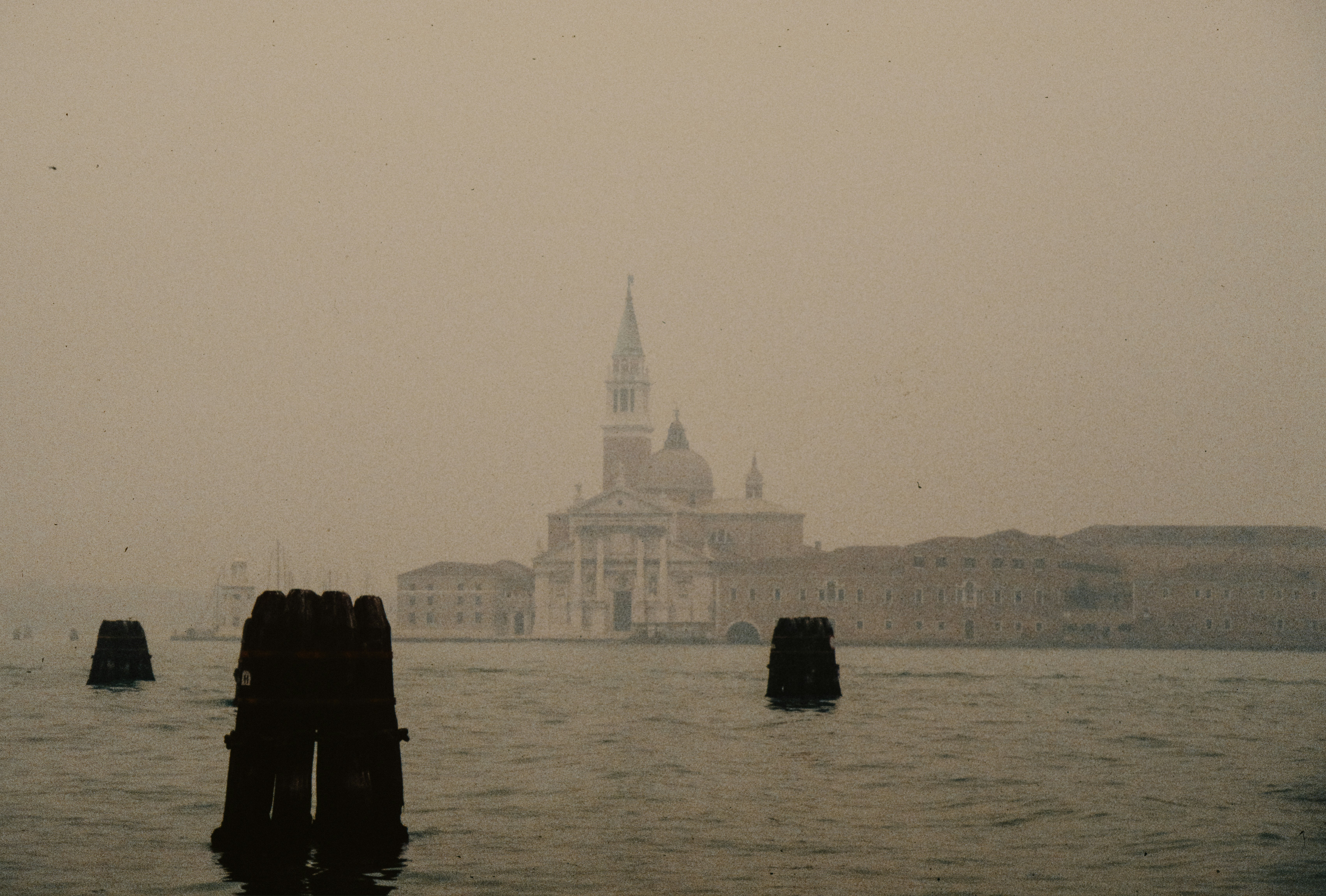Misty Venetian Coastline: St. Mark's silhouette through ferry pilings