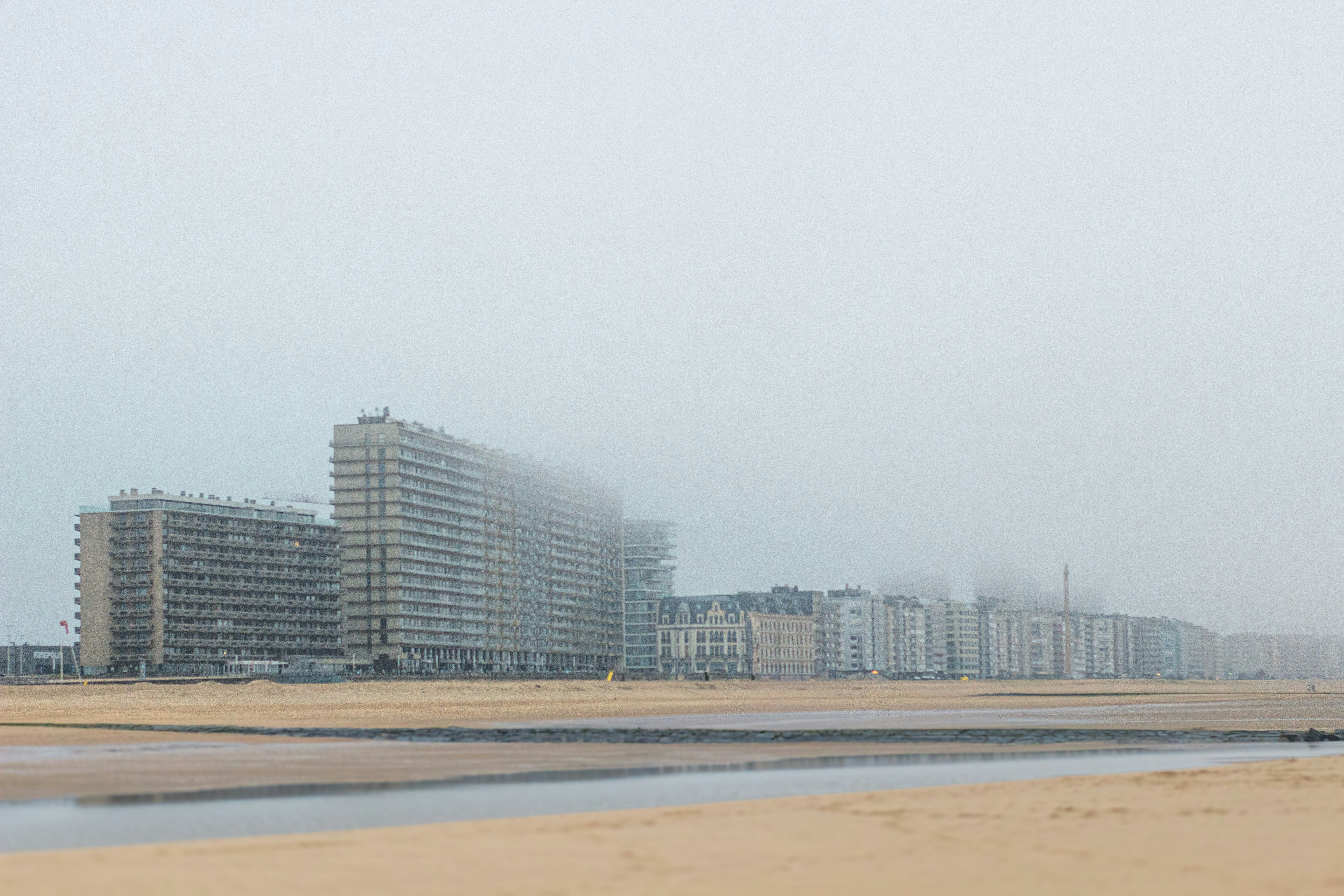 Coastal Row of Distant Towers on Misty Beachfront