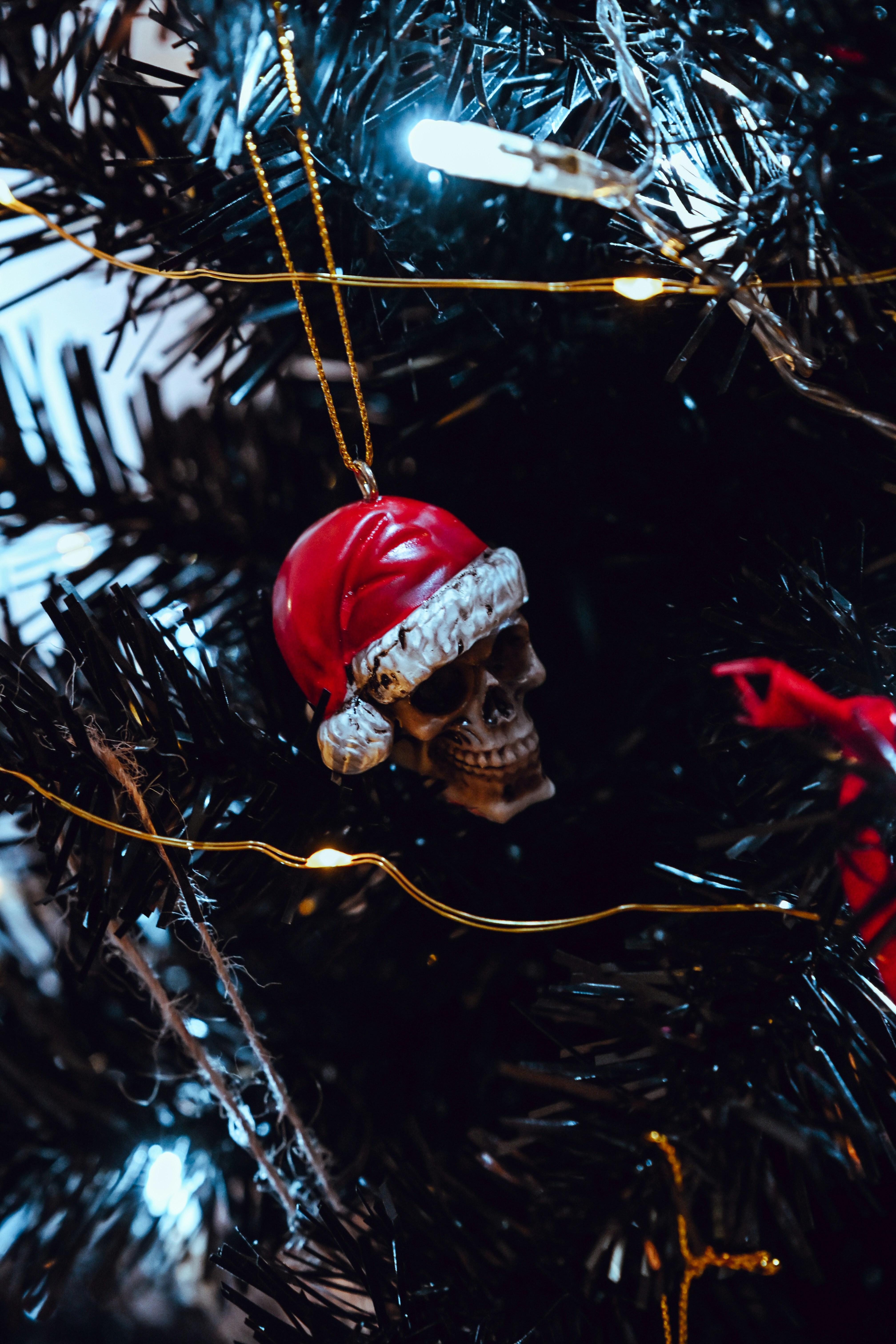 Skull ornament with santa hat on christmas tree