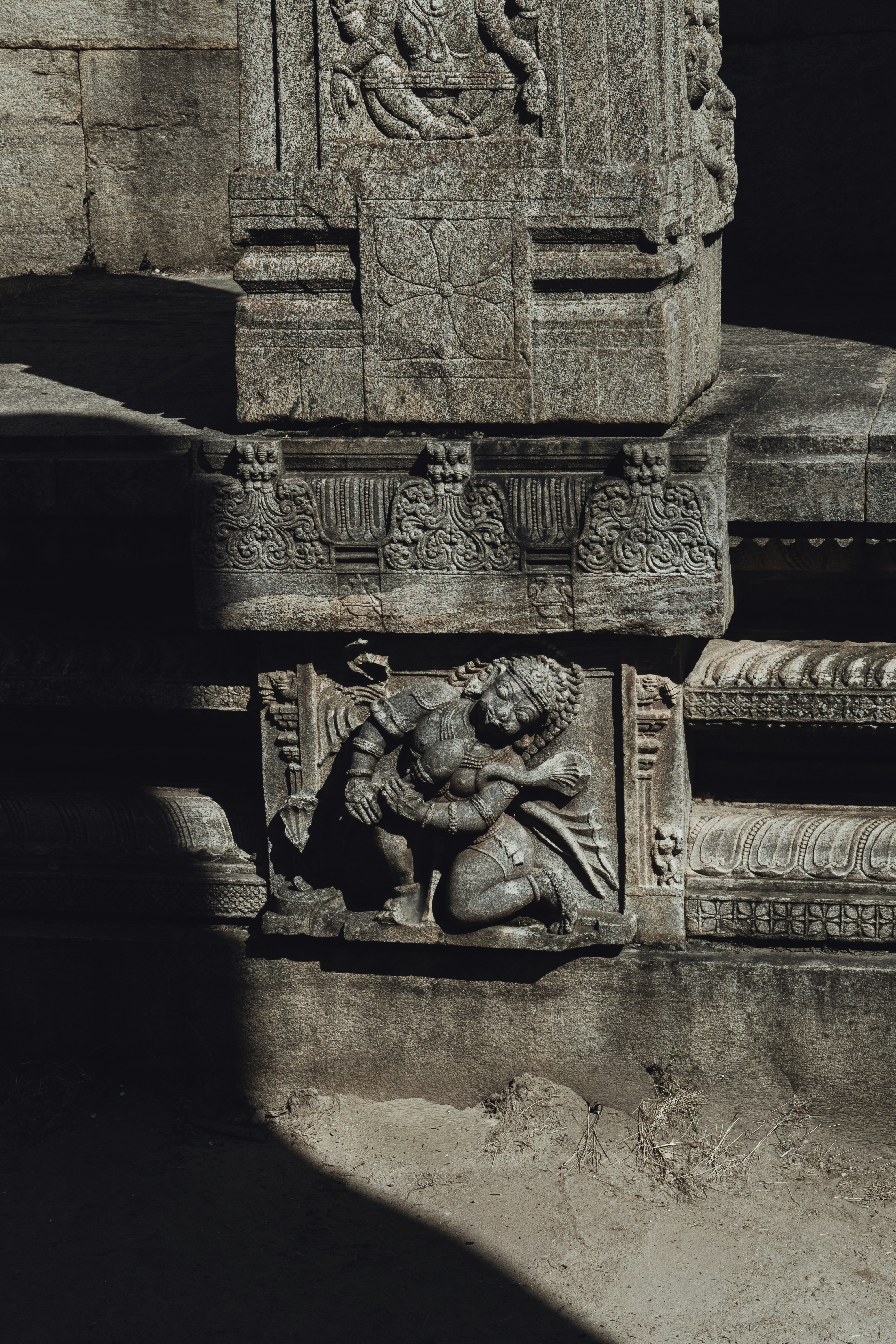 Shadowed Carved Hero: A Stone Figure in Quiet Relief