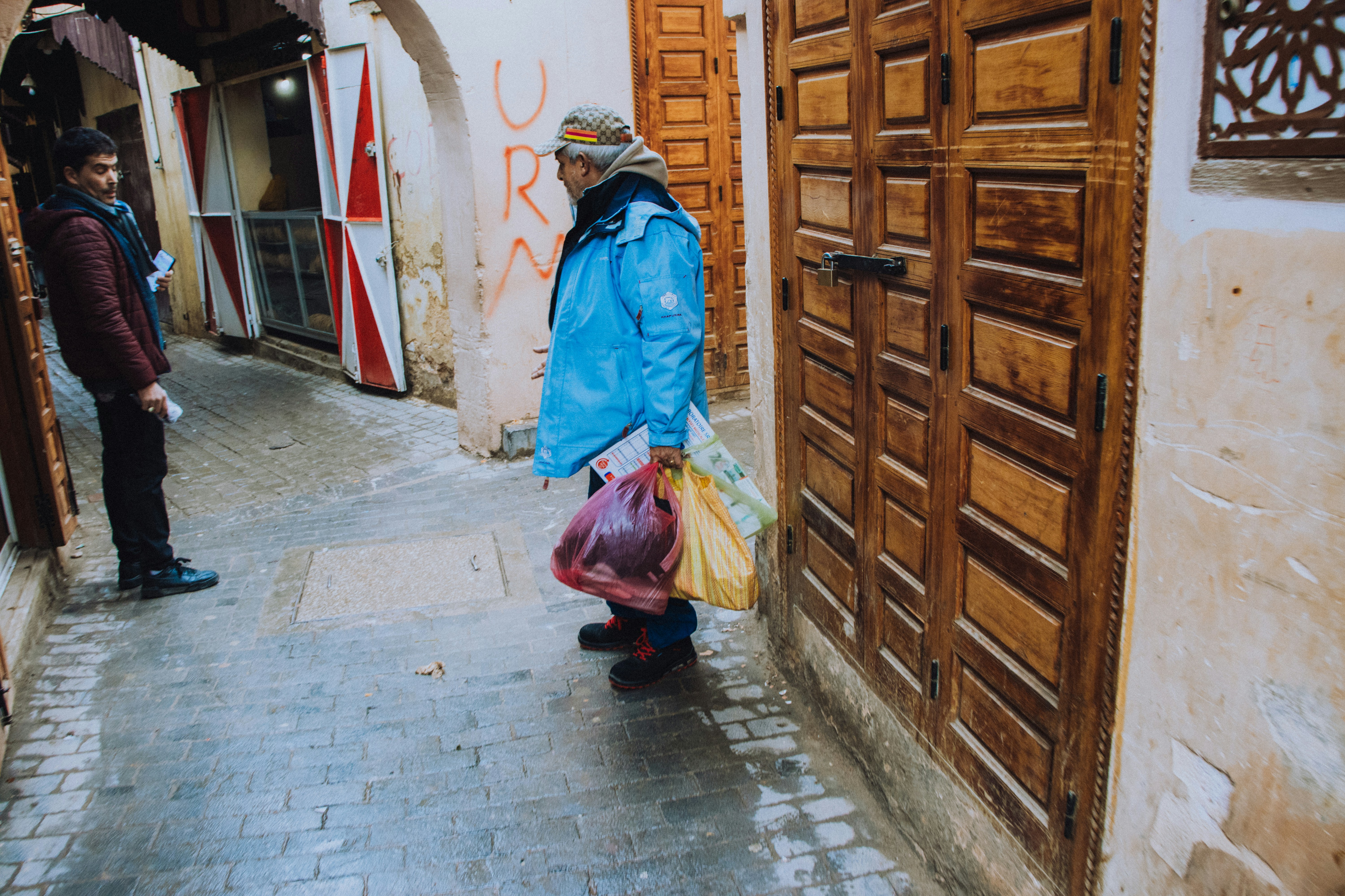 Blue-clad Shopper in a Narrow Palimpsest Lane