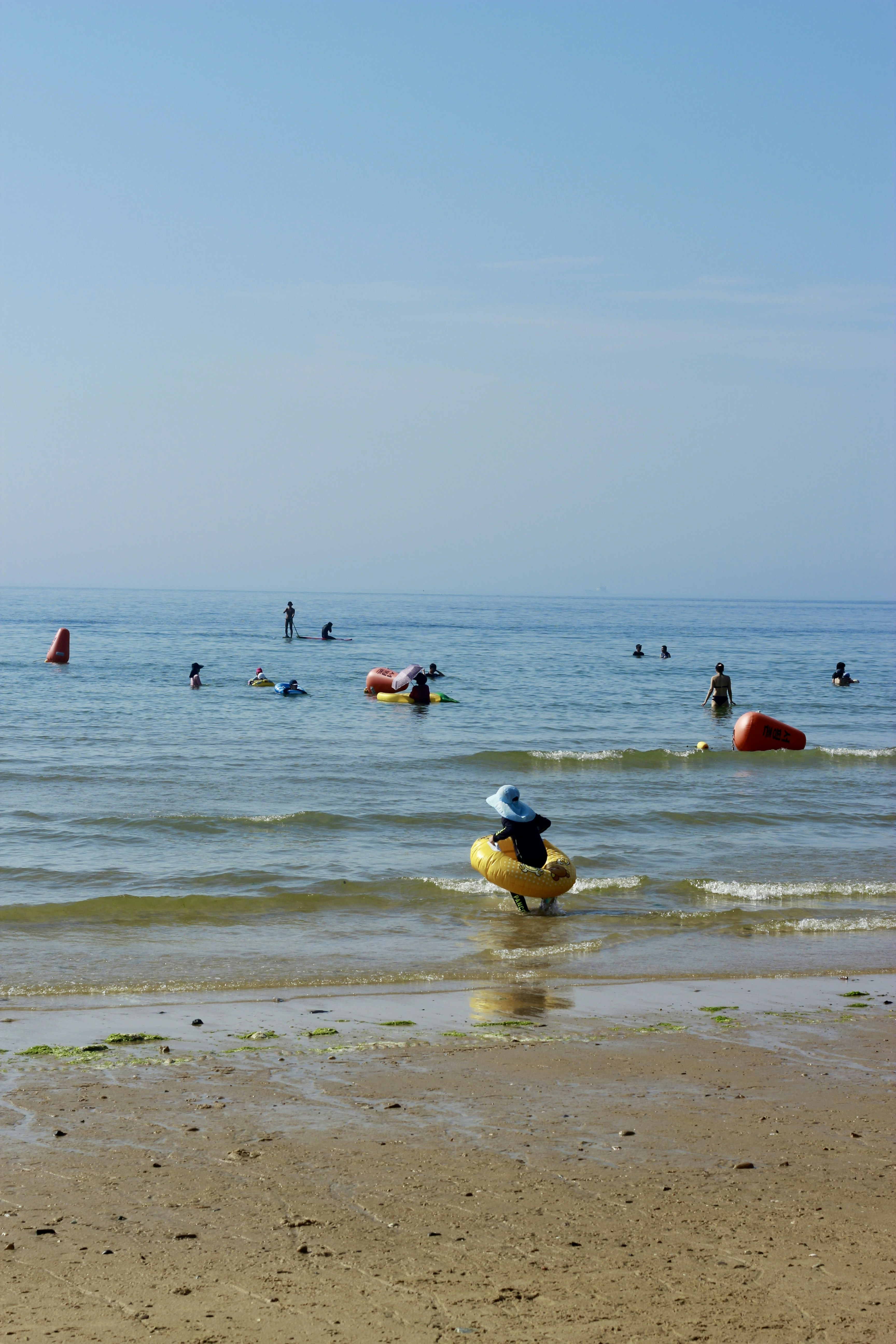 Floating Figure at the Shore: A Quiet Beach Scene