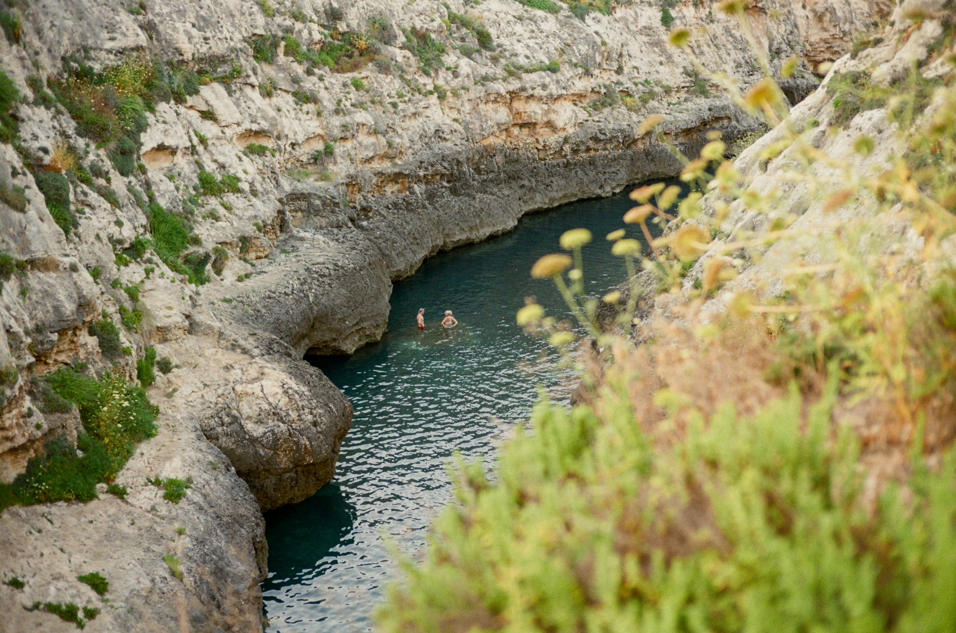 Two people swimming in a narrow sea cove. photo – Free Sea Image on ...