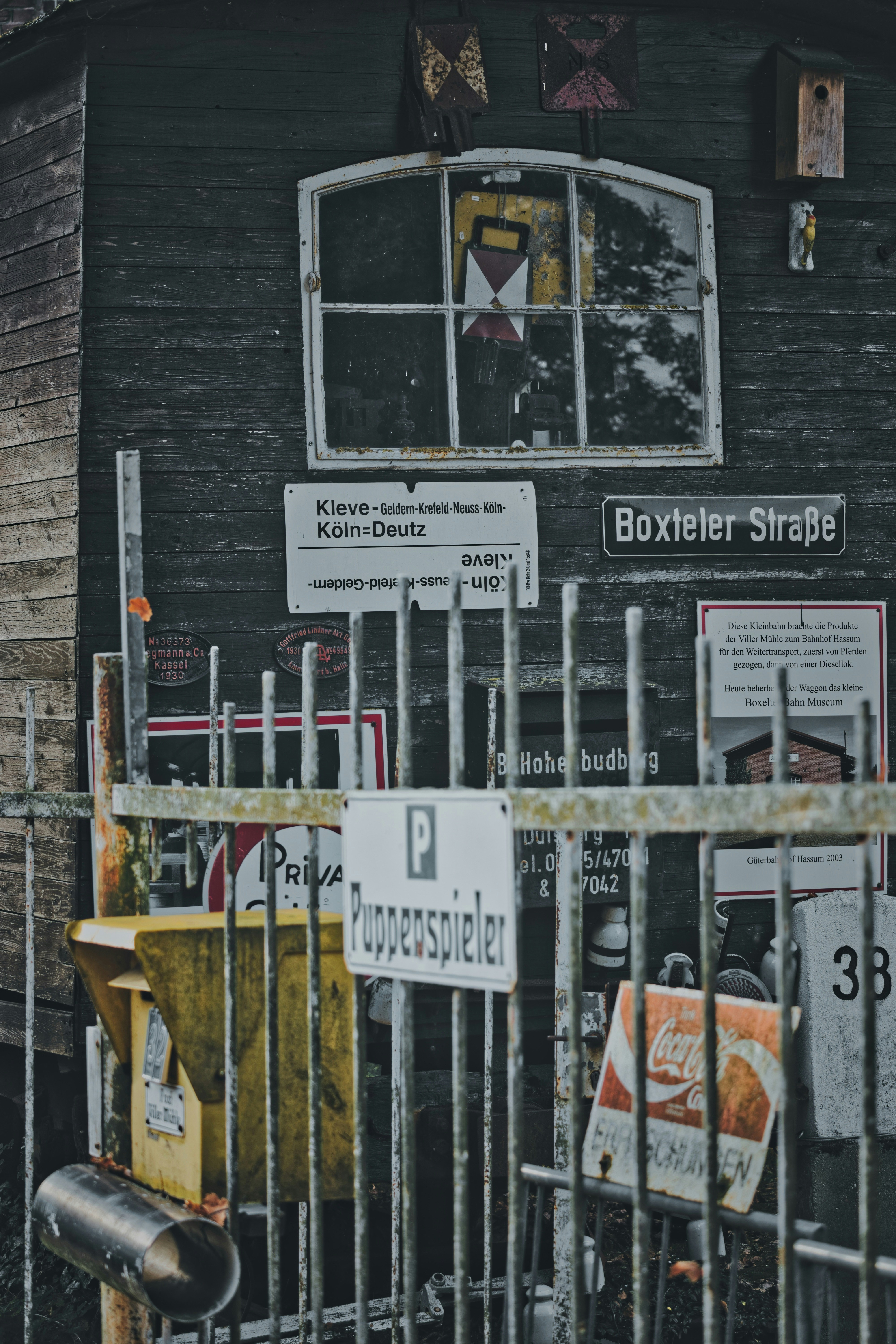 Weathered storefront relics: a zebra of signs and bars