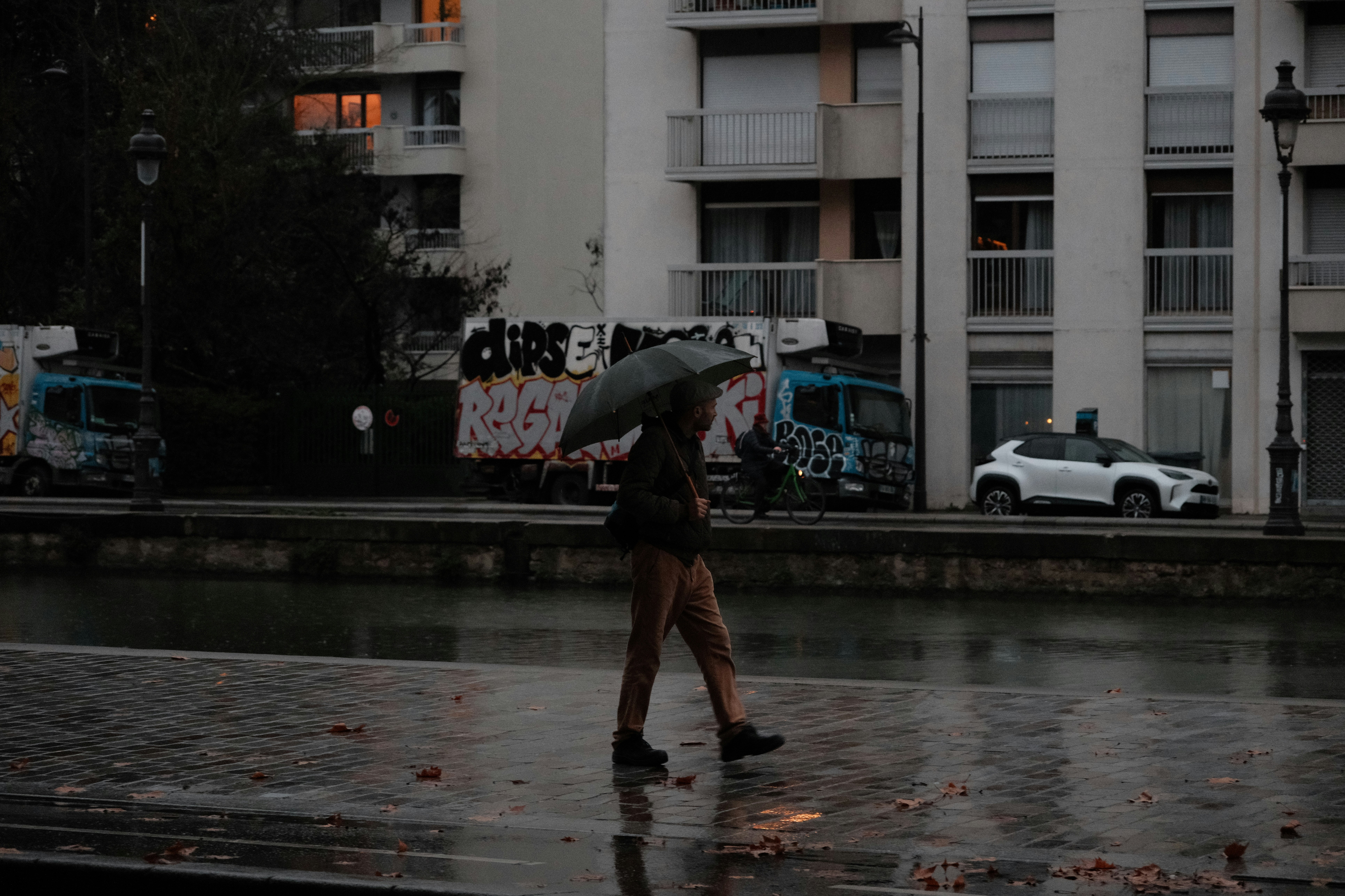 Rainy Street Stroll Under a Single Umbrella