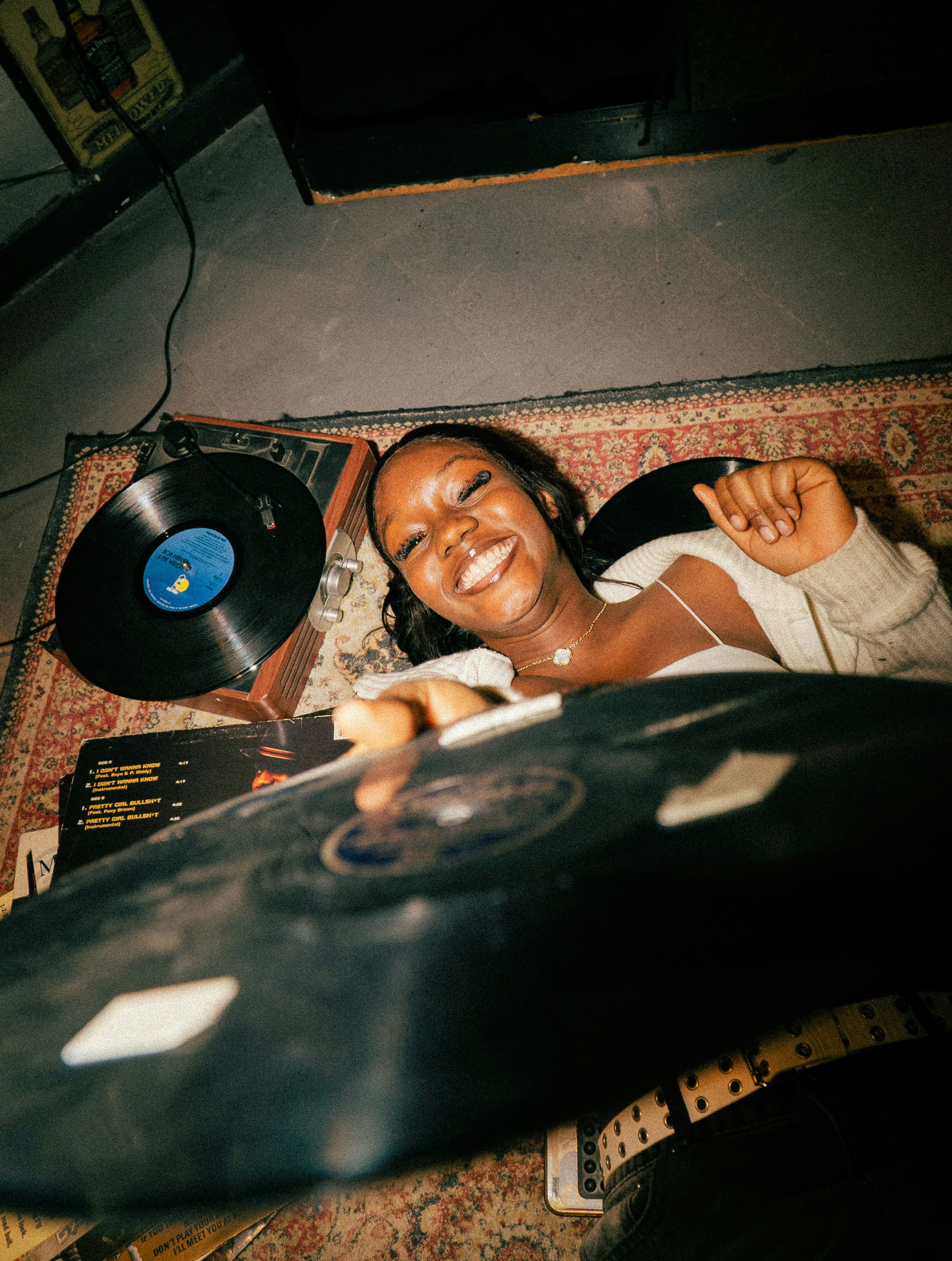 Joyful DJ Moment: Portrait Beneath a Vinyl Glow