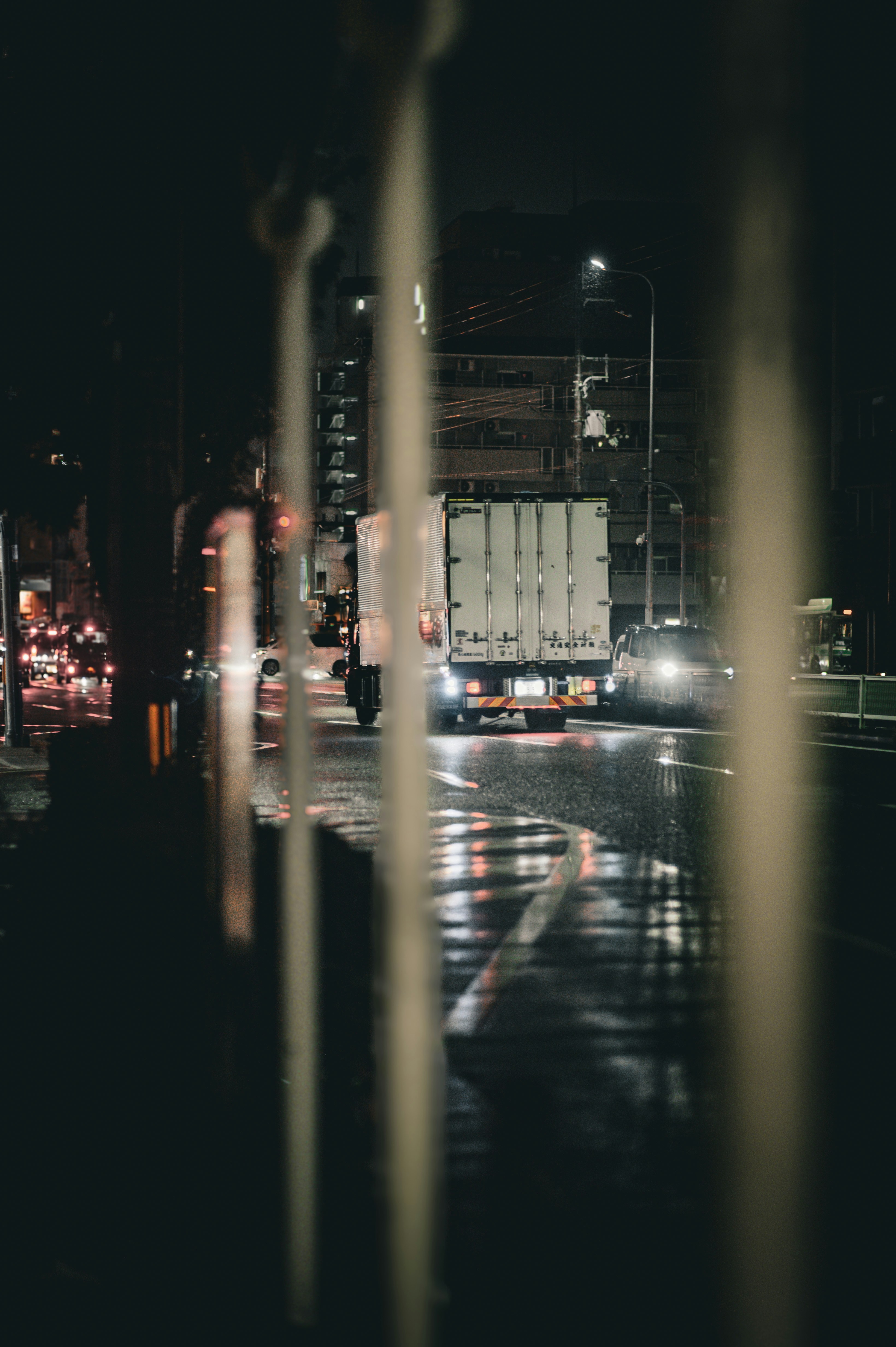 Headlights through Rain: Night Freight on a Neon Street