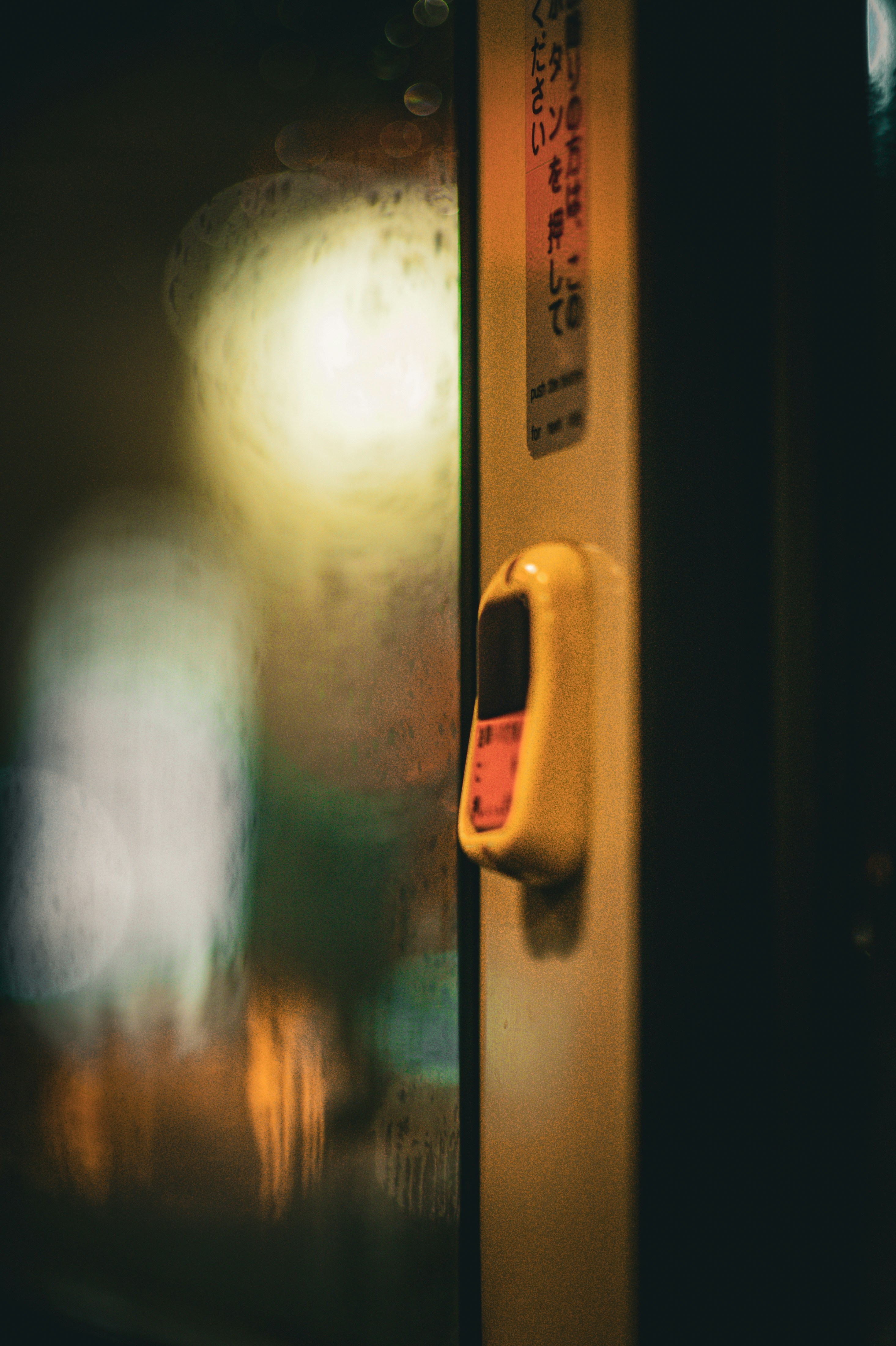 Soft Neon Reflections on a Doorway Keypad