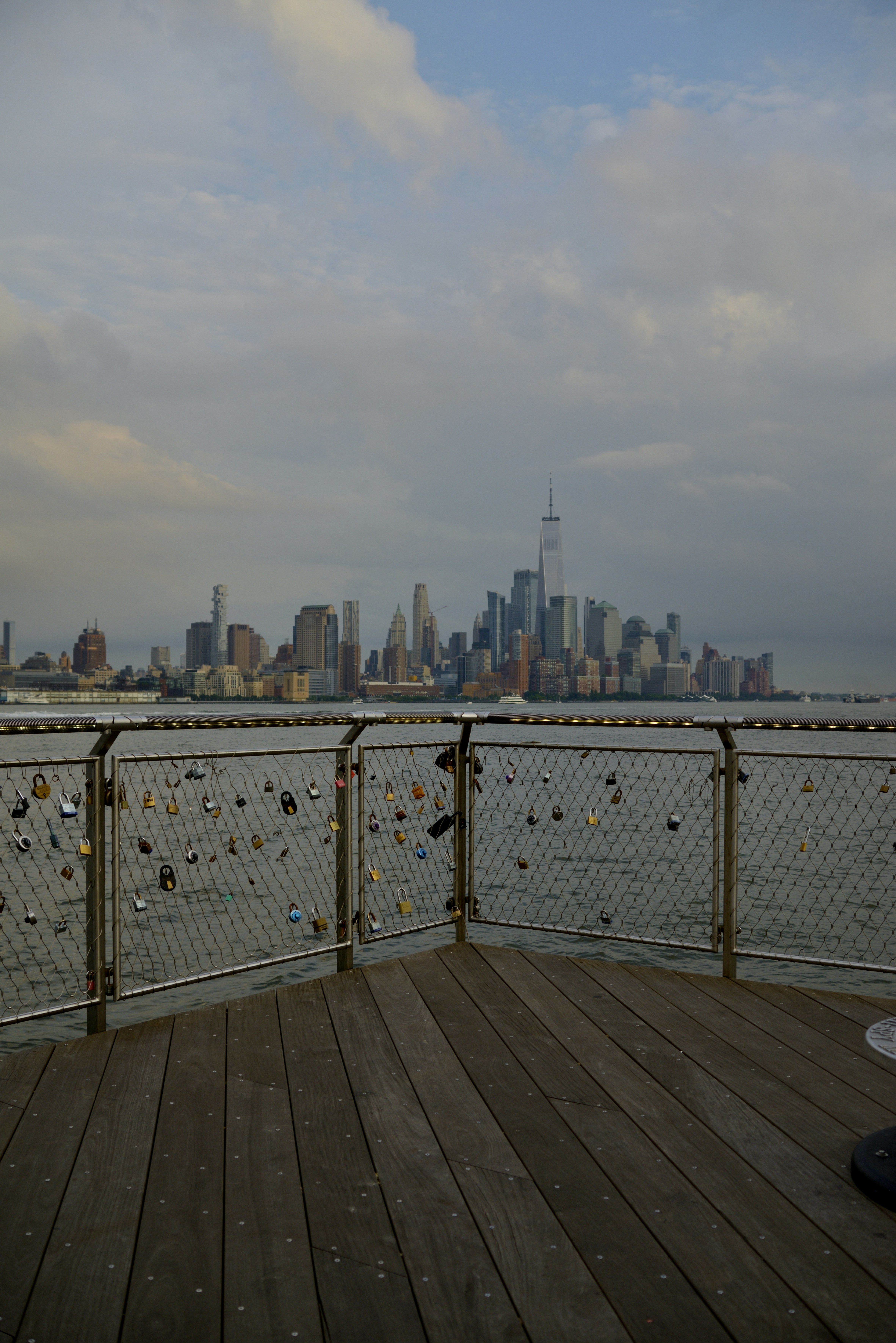 Rusted rails to skyline: a pier’s view toward a distant city