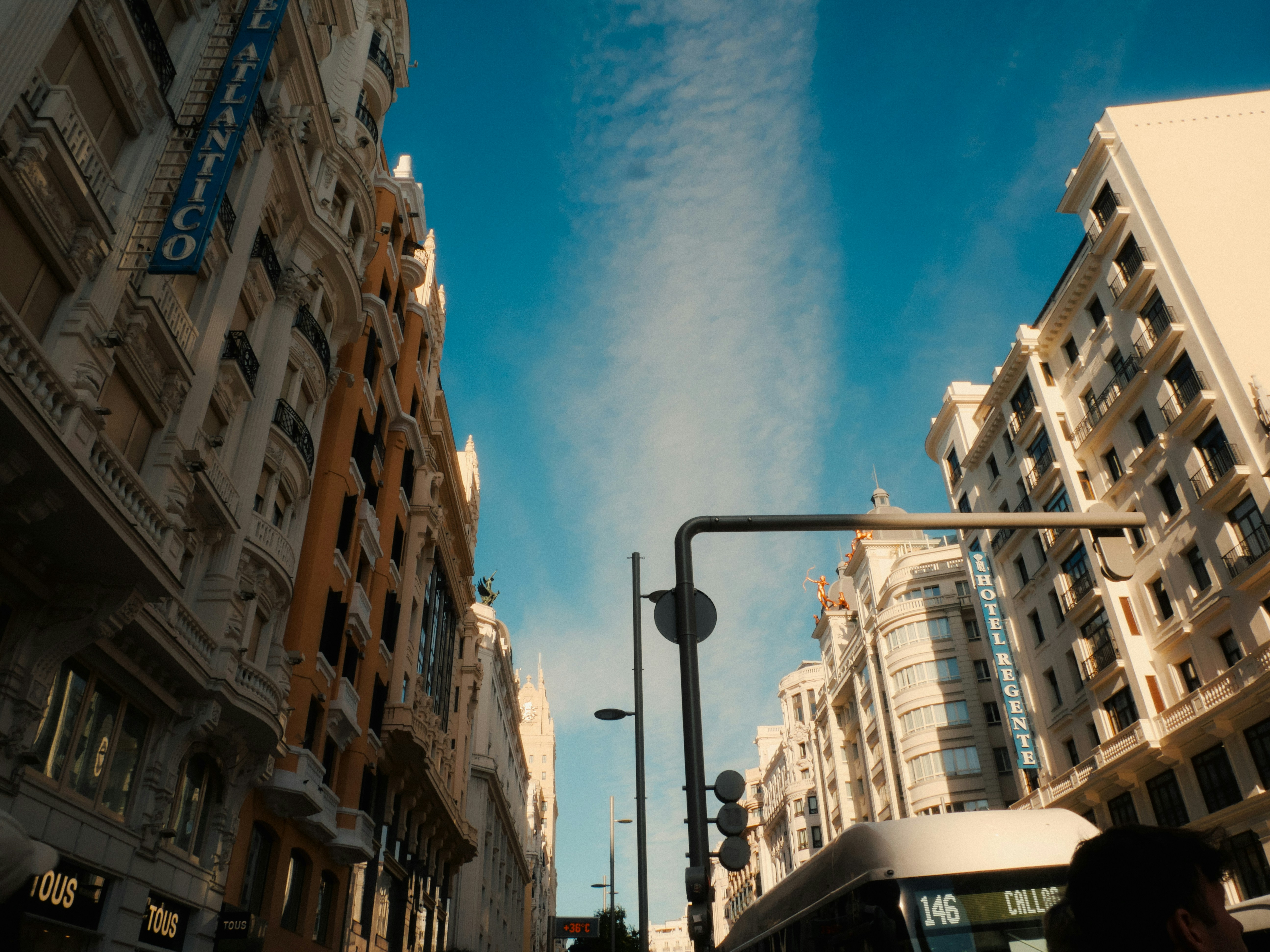 Urban Canyon: Street Between Classic Facades Reaching Toward a Blue Sky