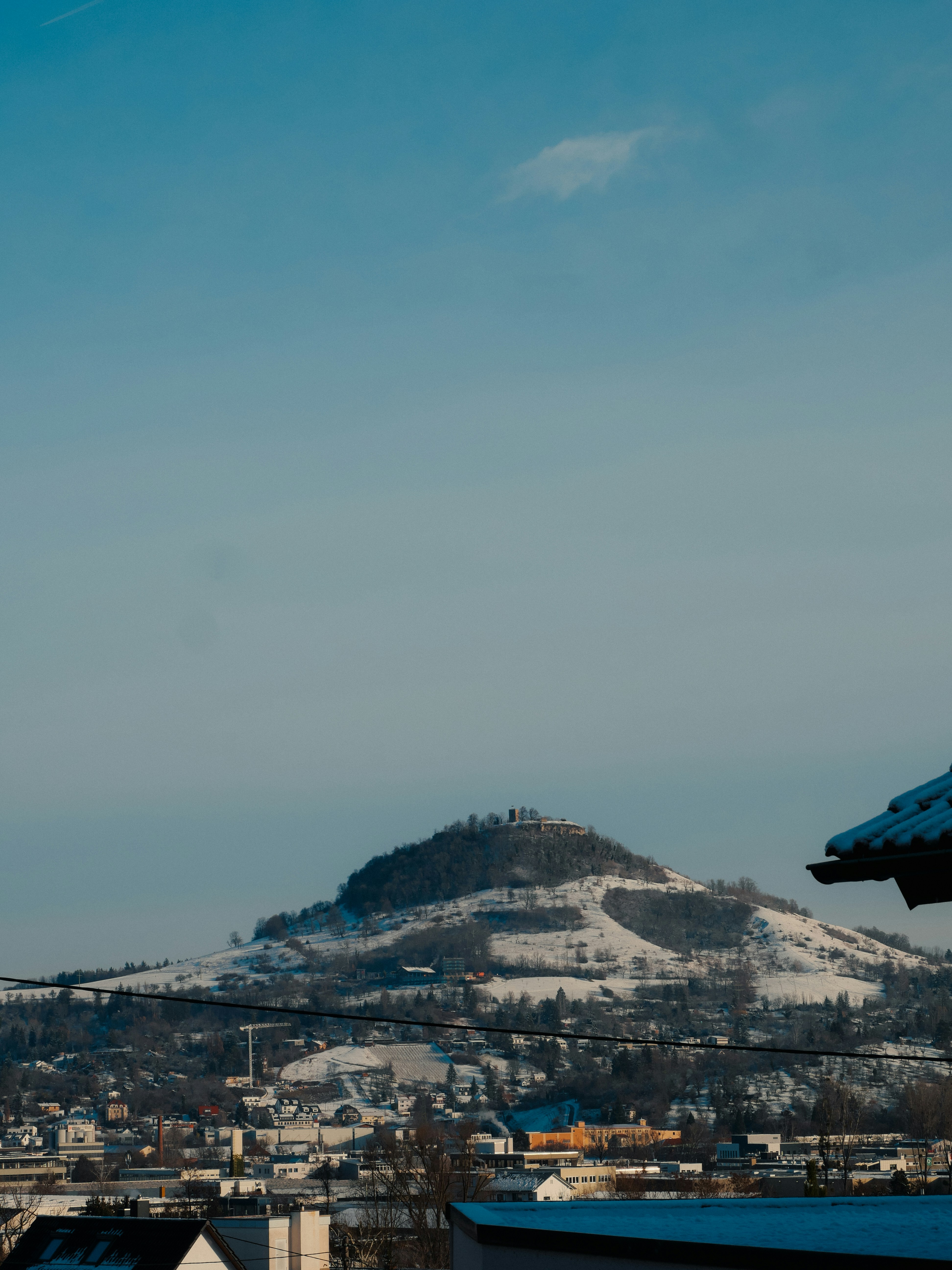 Snow-dusted hilltop village beneath a clear winter sky